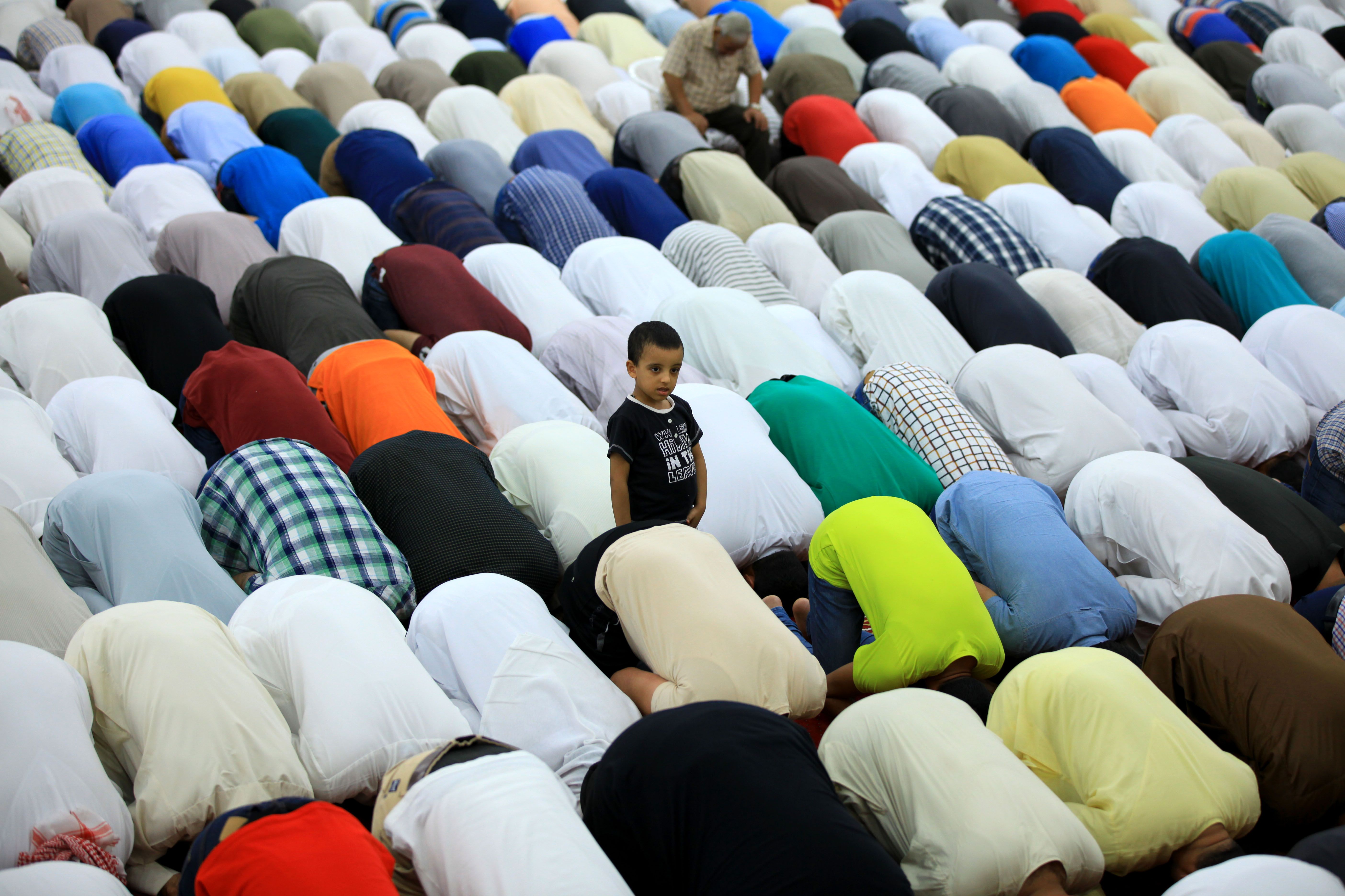 A Boy Surrounded by Men Bowing Down on the Ground · Free Stock Photo