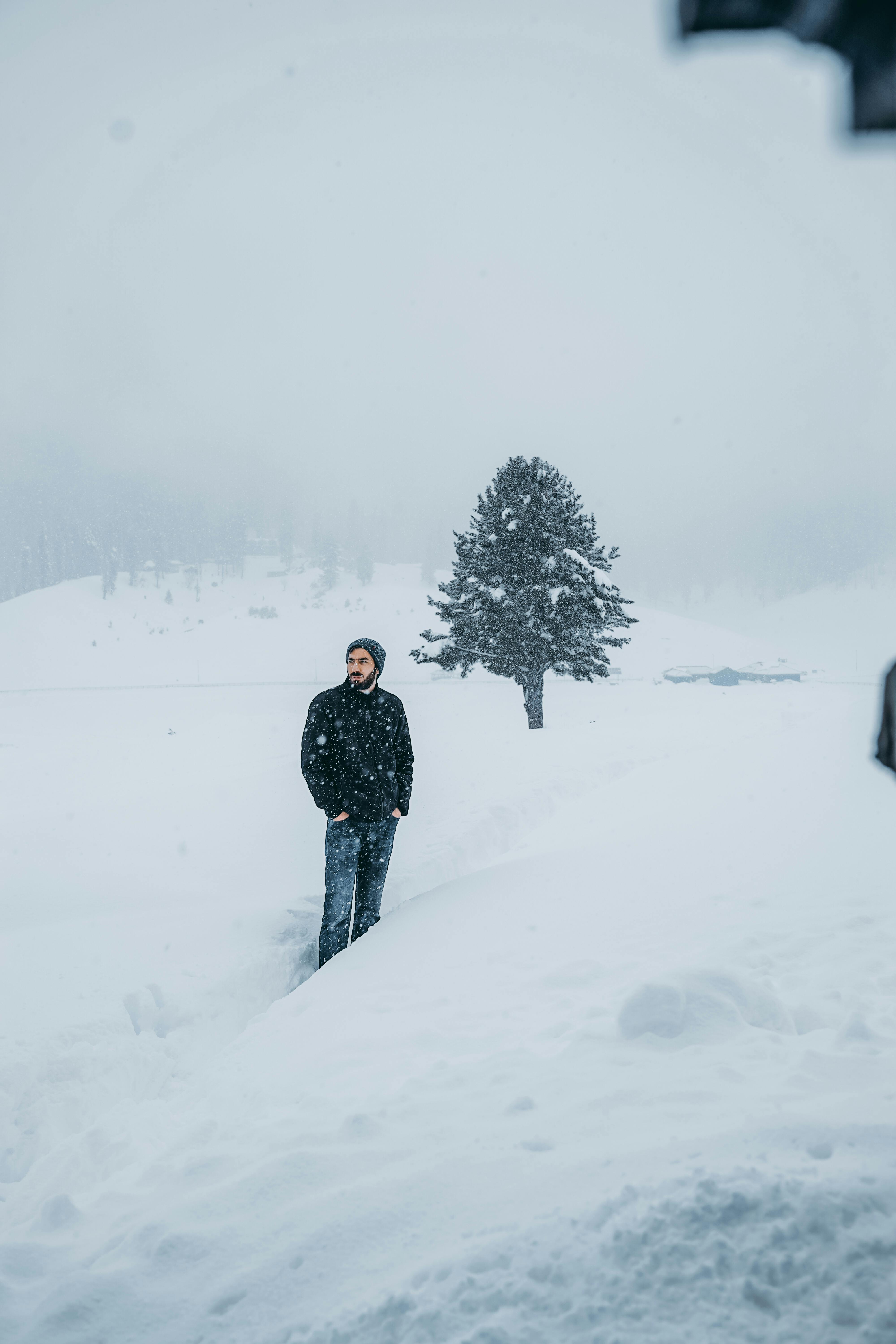 Person in Black Coat Walking on Snow Covered Pathway · Free Stock Photo