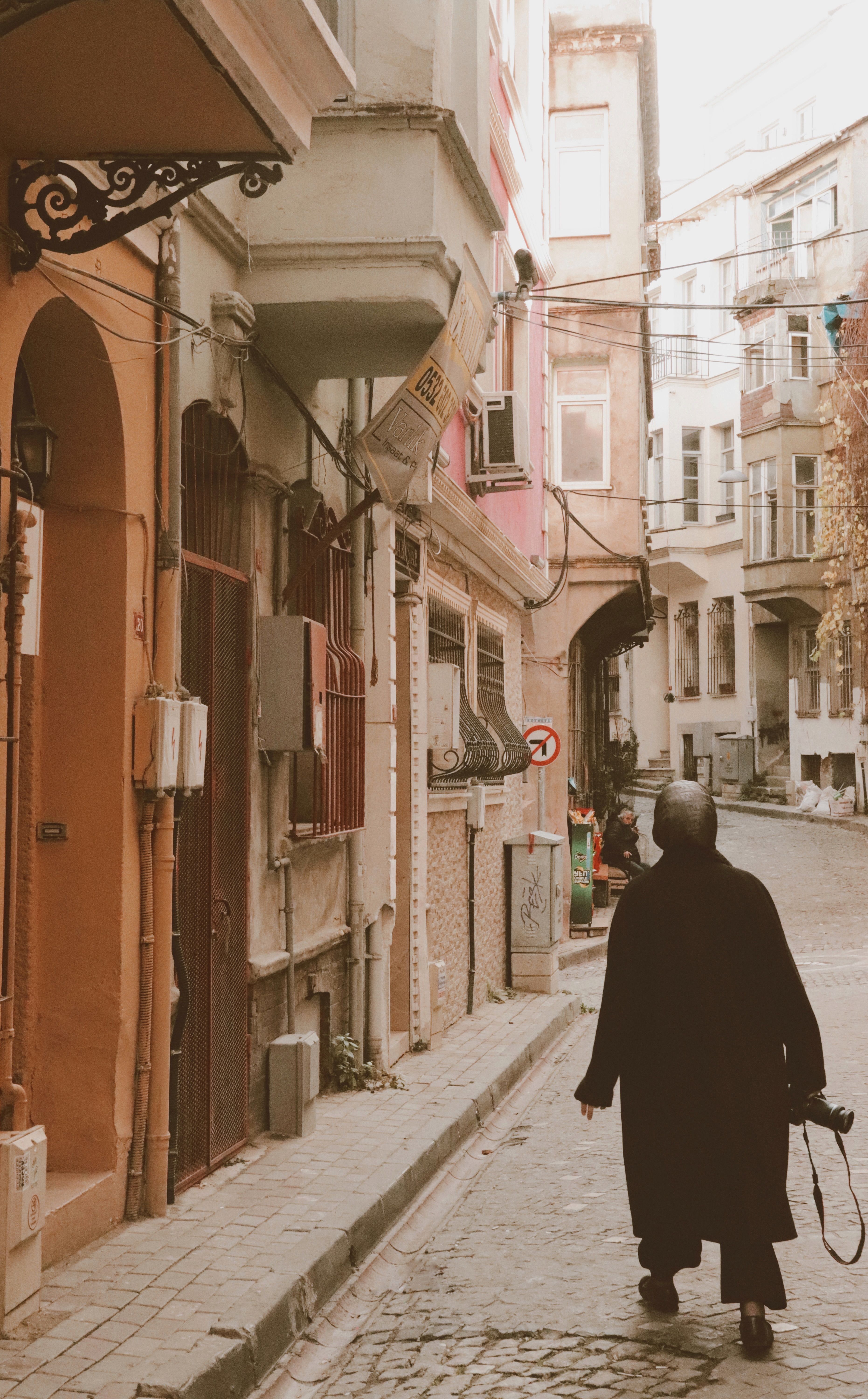 Back View of Person Carrying a Camera while Walking · Free Stock Photo