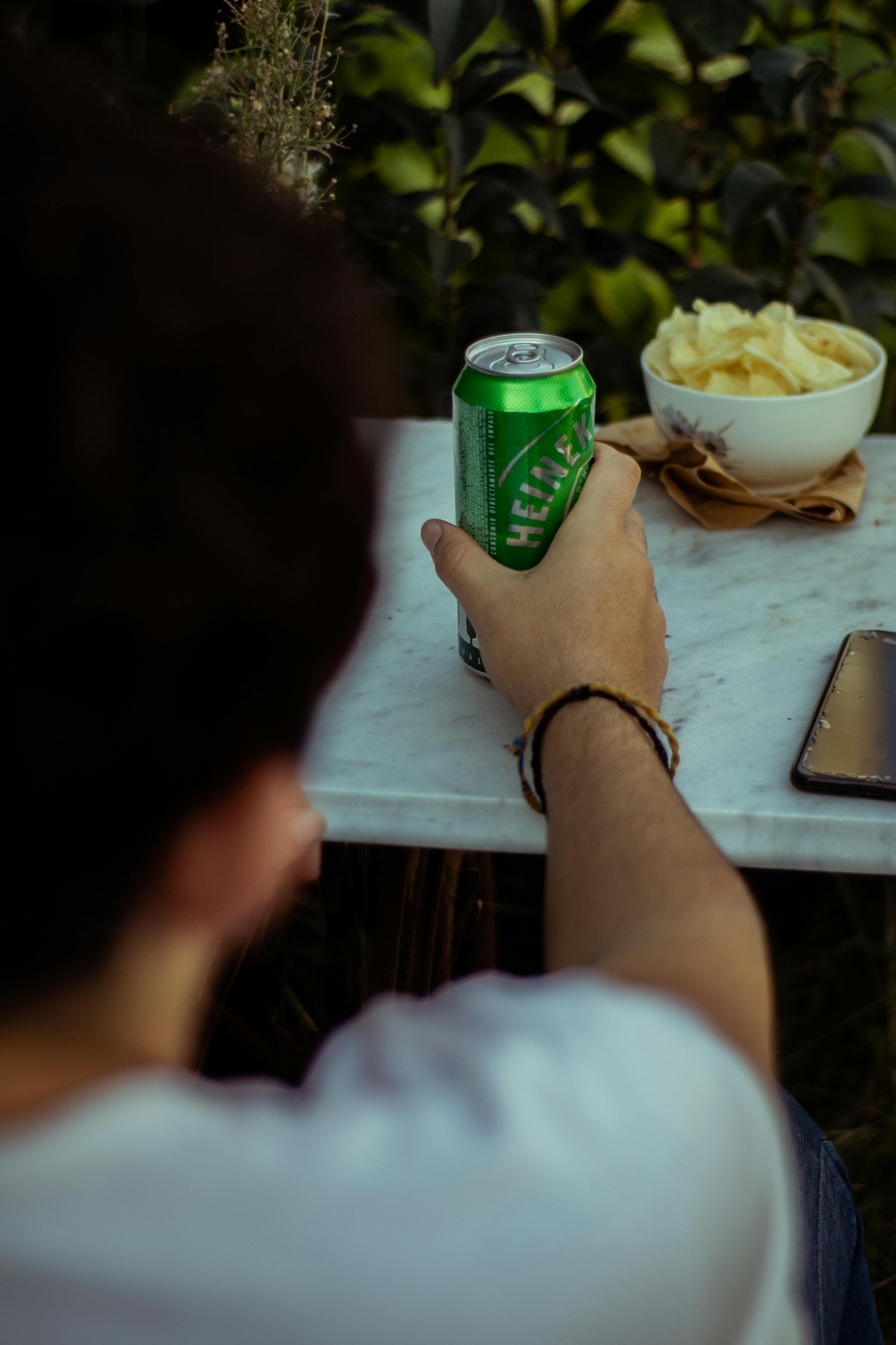 Man Sitting at Table with Beer Bottle · Free Stock Photo
