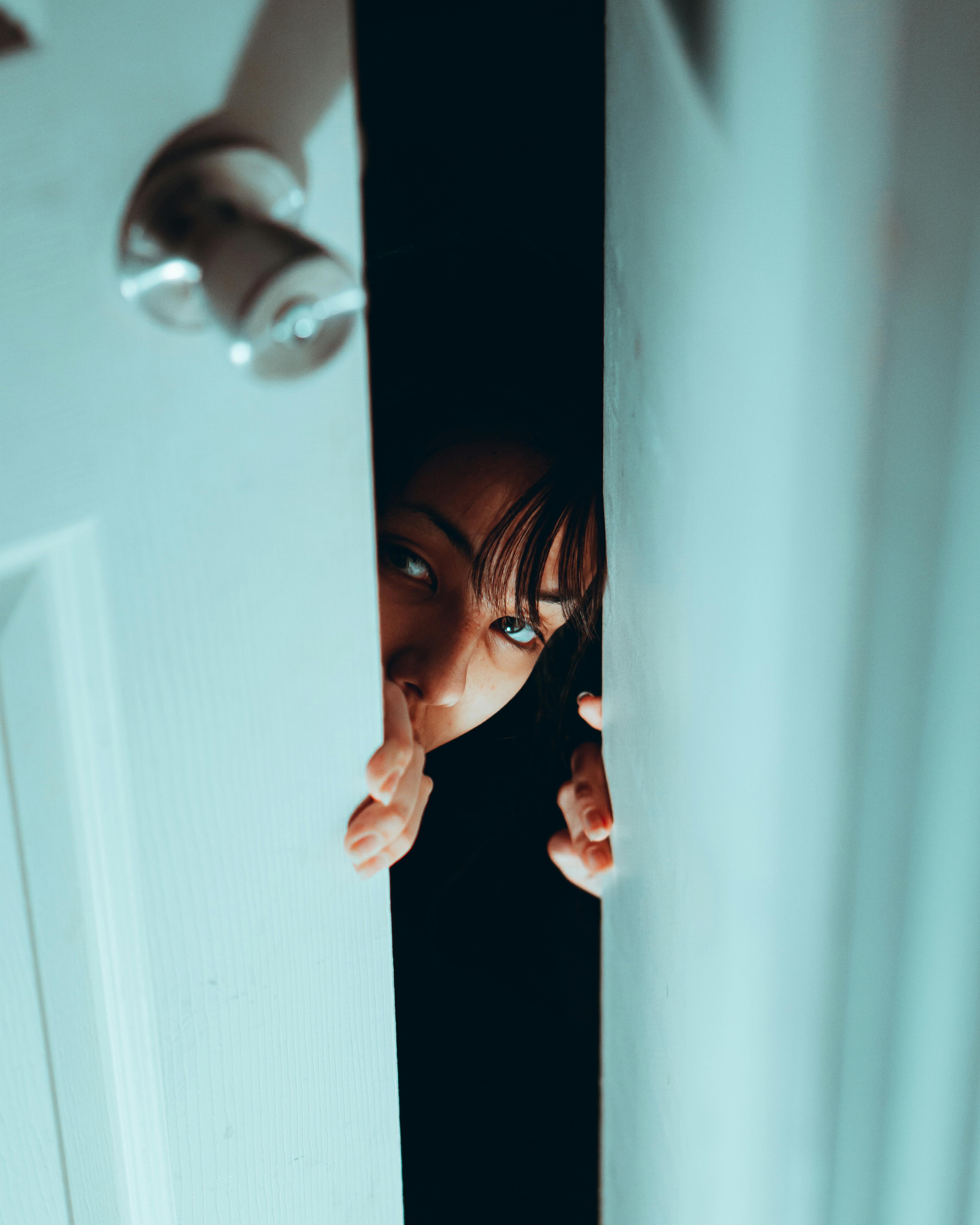 Woman Peeking through Door · Free Stock Photo