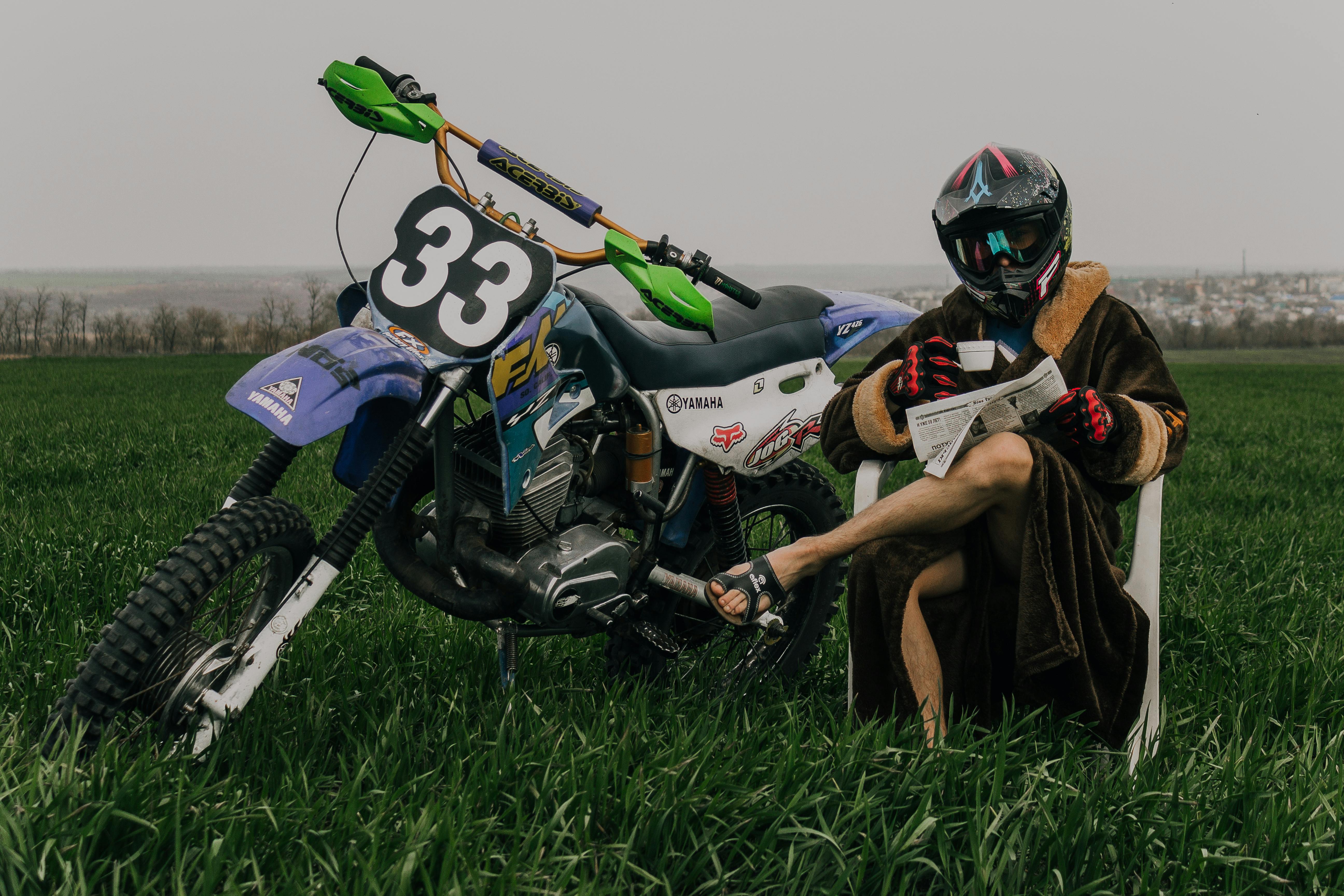 Rider sitting beside his Dirtbike · Free Stock Photo