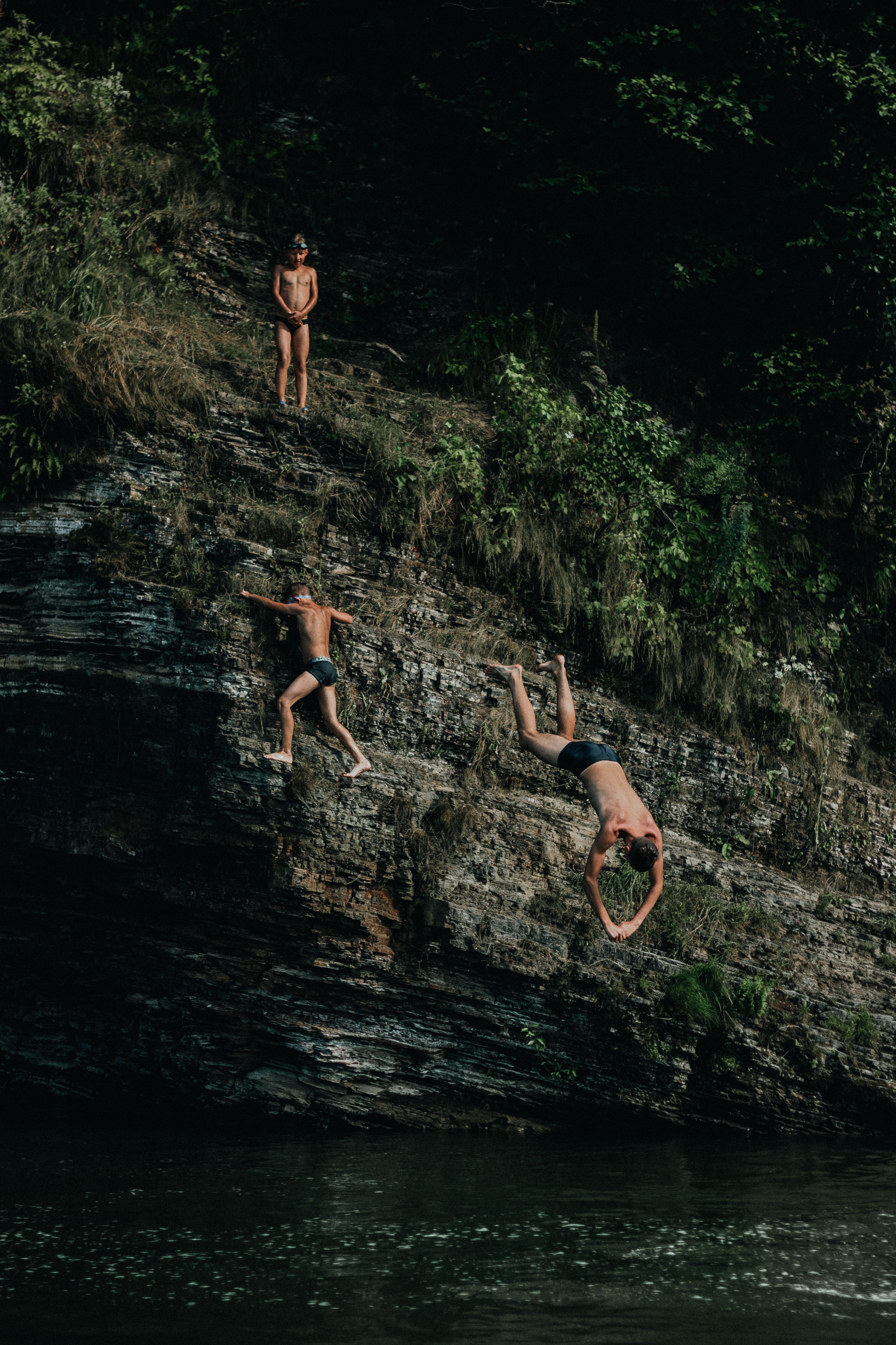 Boys Diving from Rock Formation · Free Stock Photo