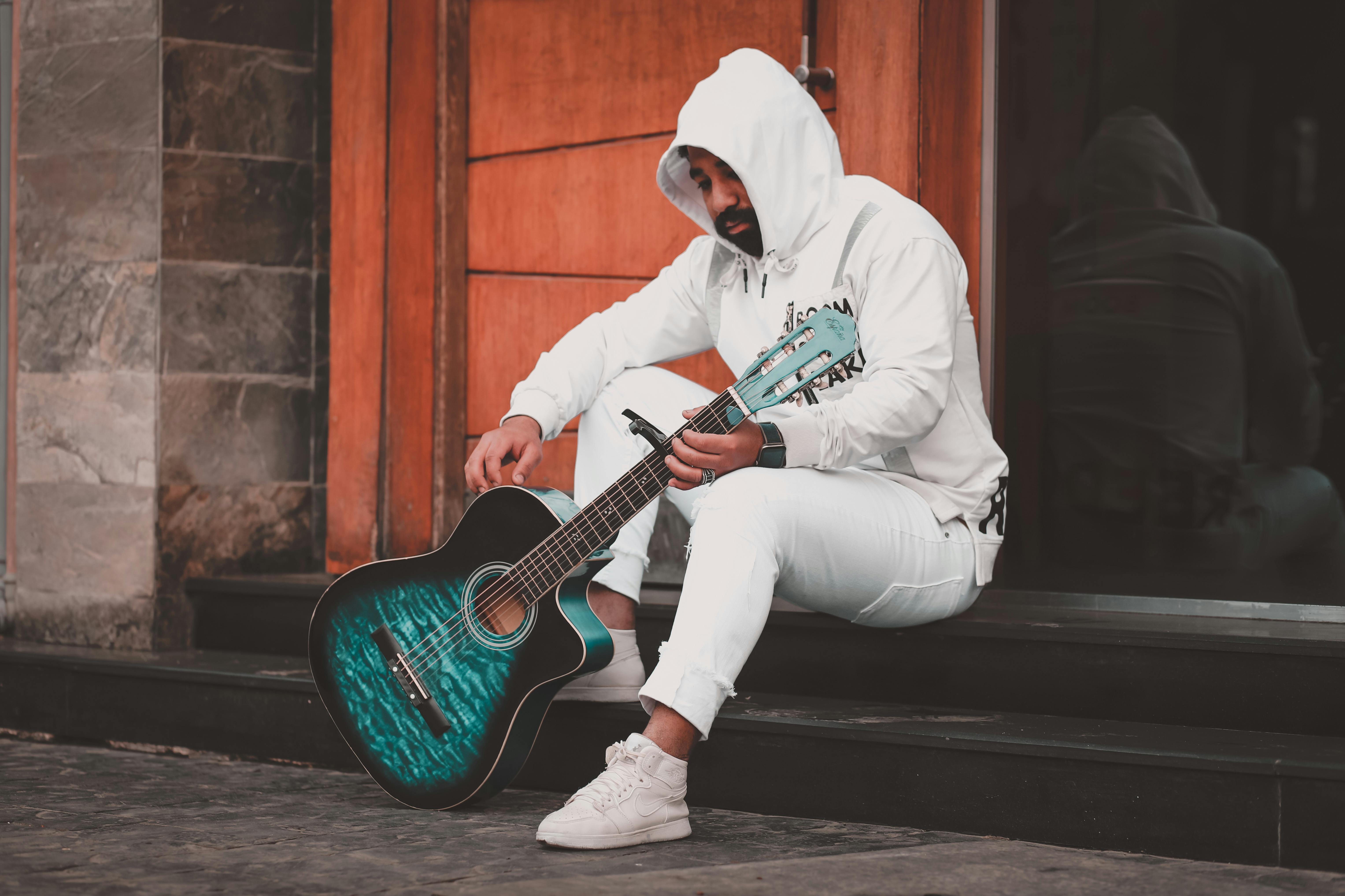 Man carrying Acoustic Guitar looking at the View · Free Stock Photo