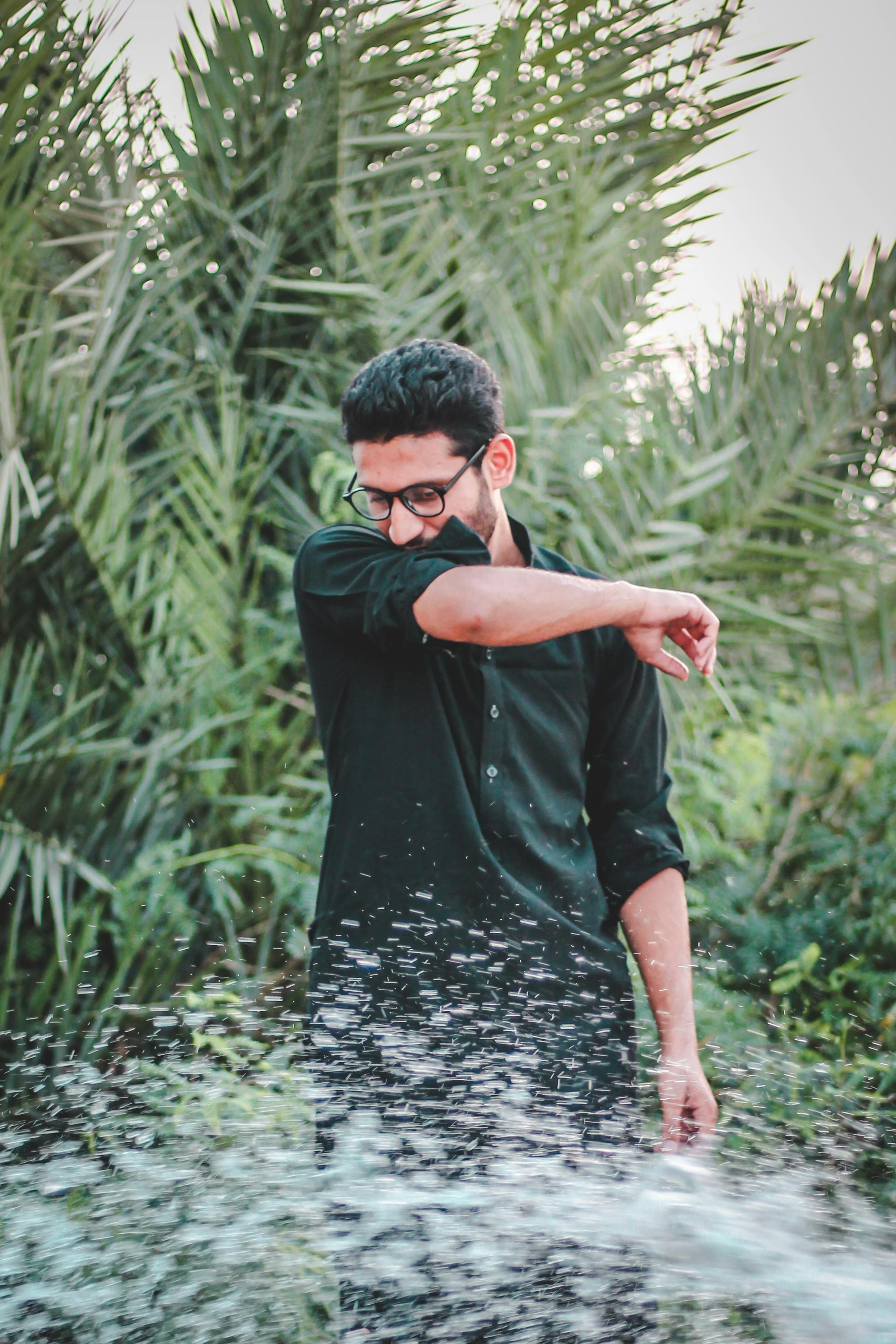 Man Holding a Stick with Perched Bird · Free Stock Photo