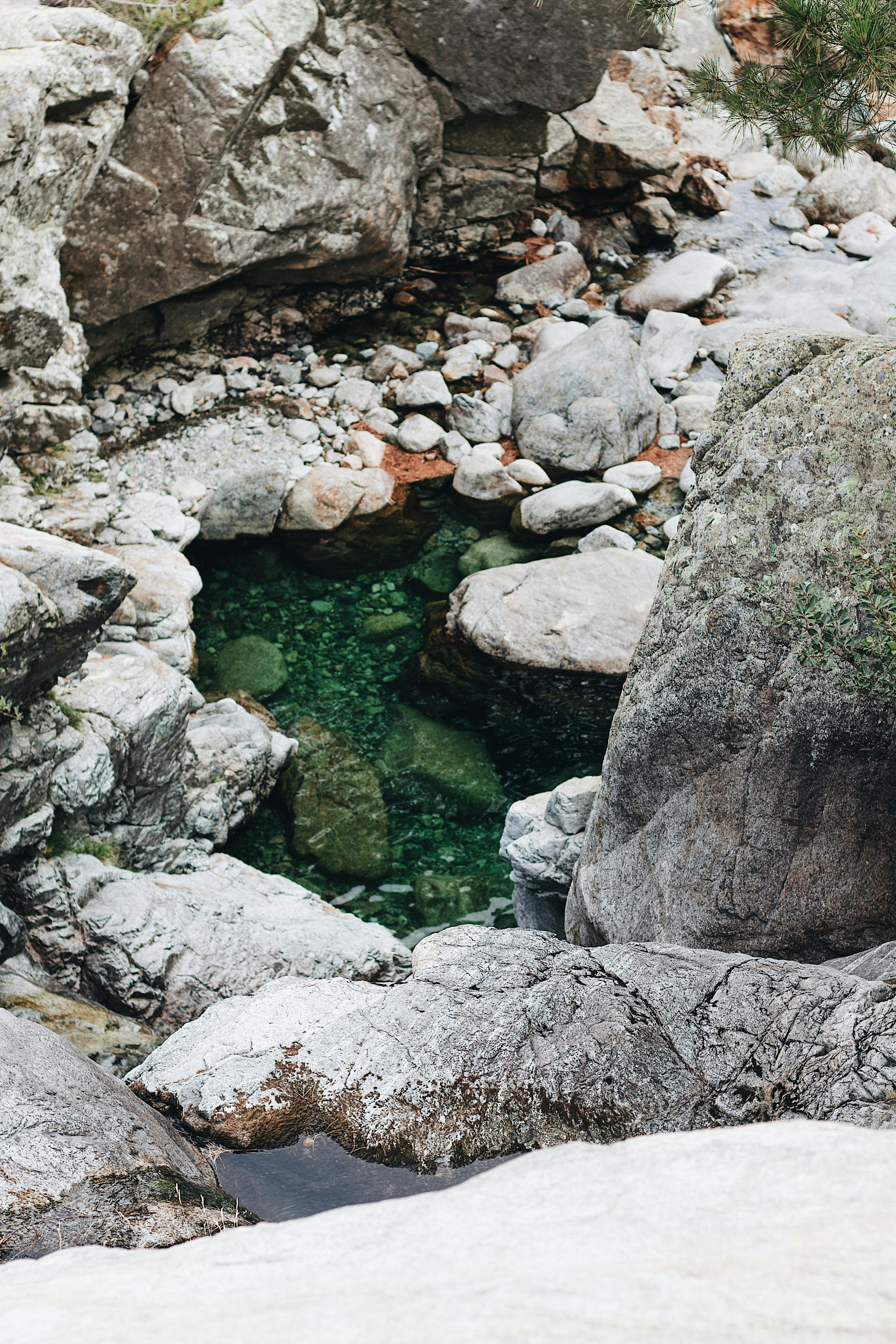 Body of Water Surrounded by Rocks · Free Stock Photo