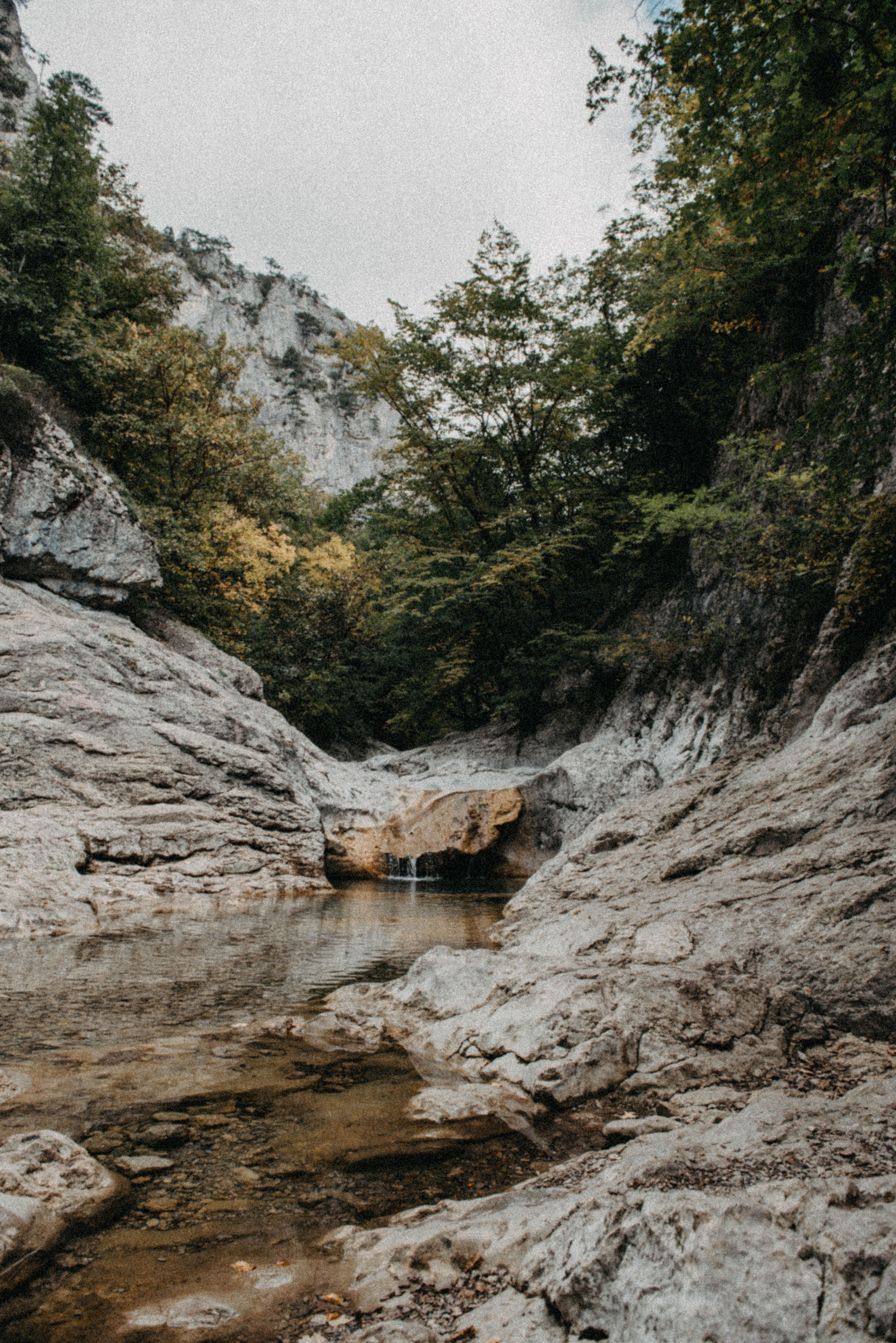 Cascade between Large Rock Formations on a Forest · Free Stock Photo