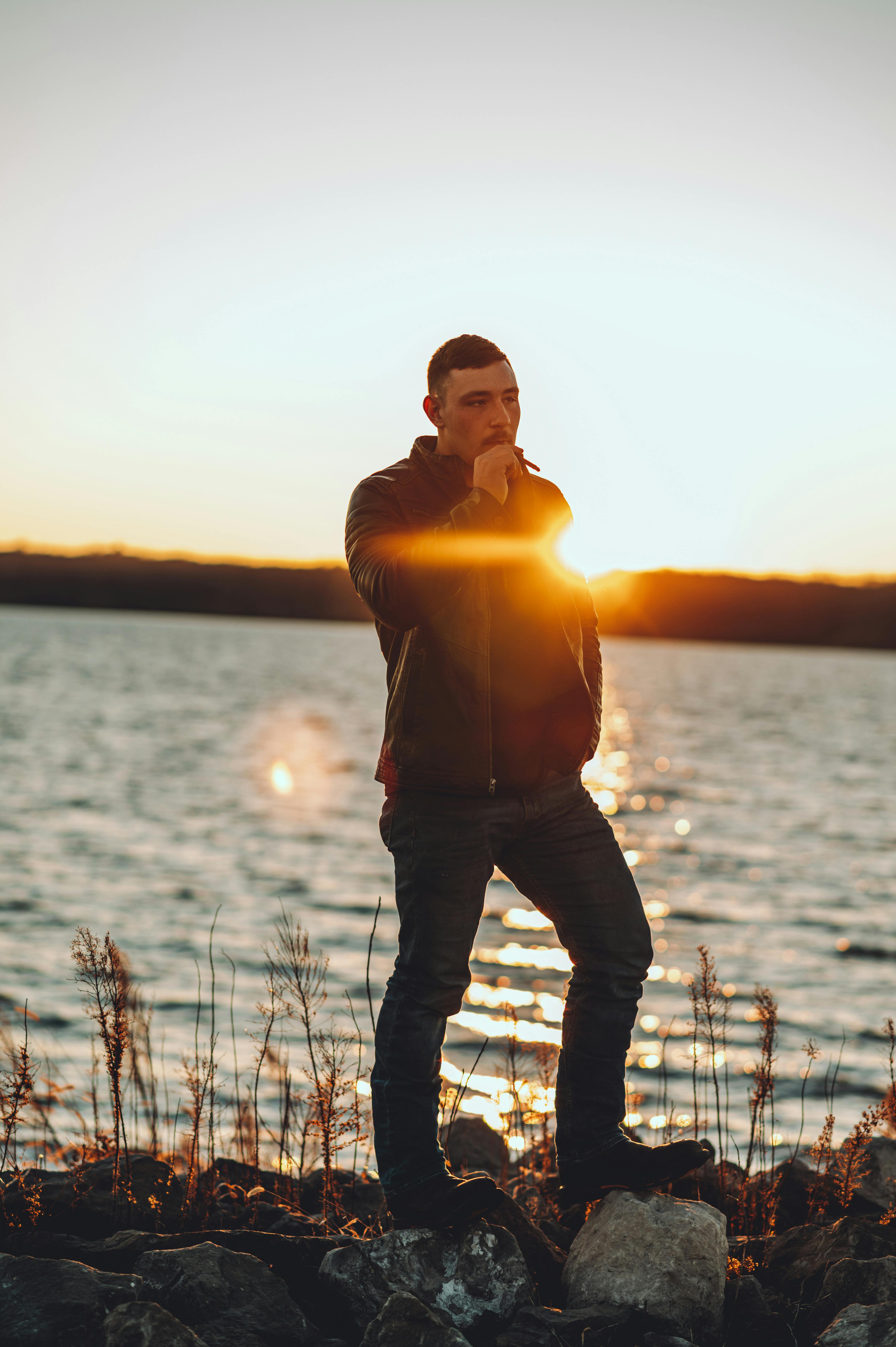 Man Jumping on Rocks Over a River · Free Stock Photo