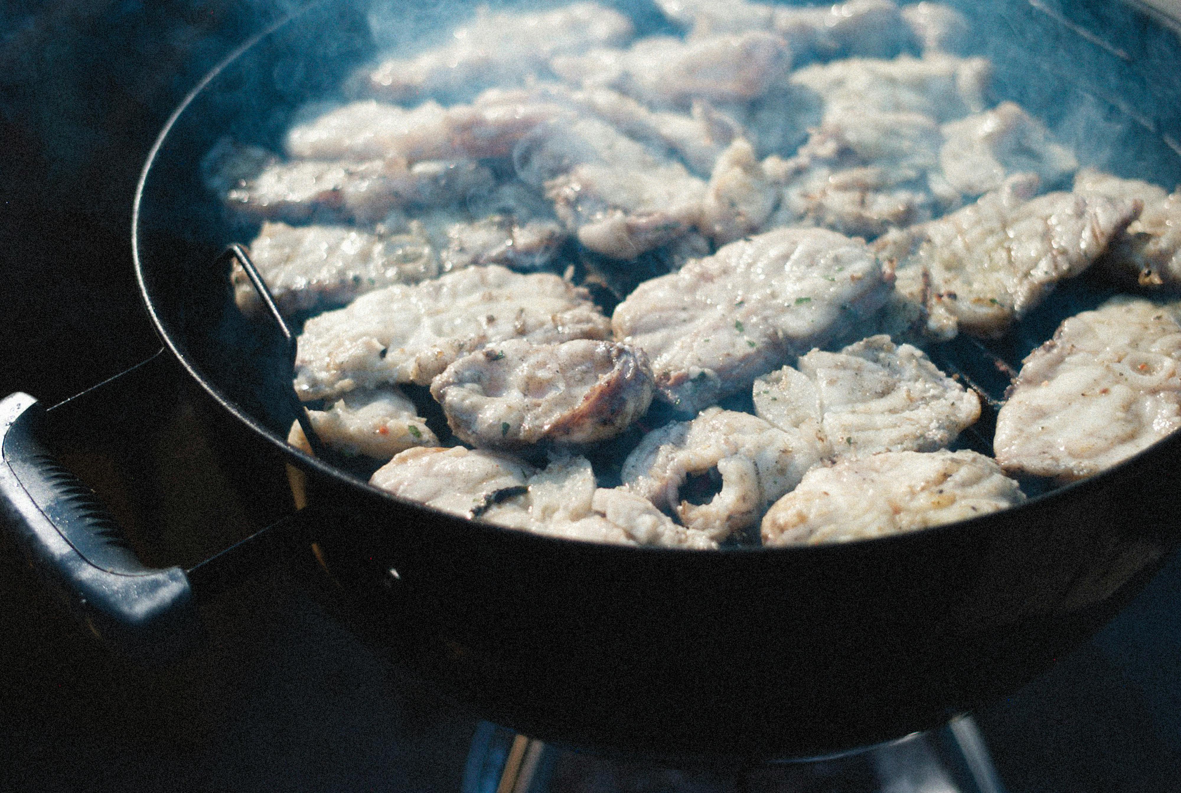 Man Cooking Chicken on Grill on Street Stall · Free Stock Photo