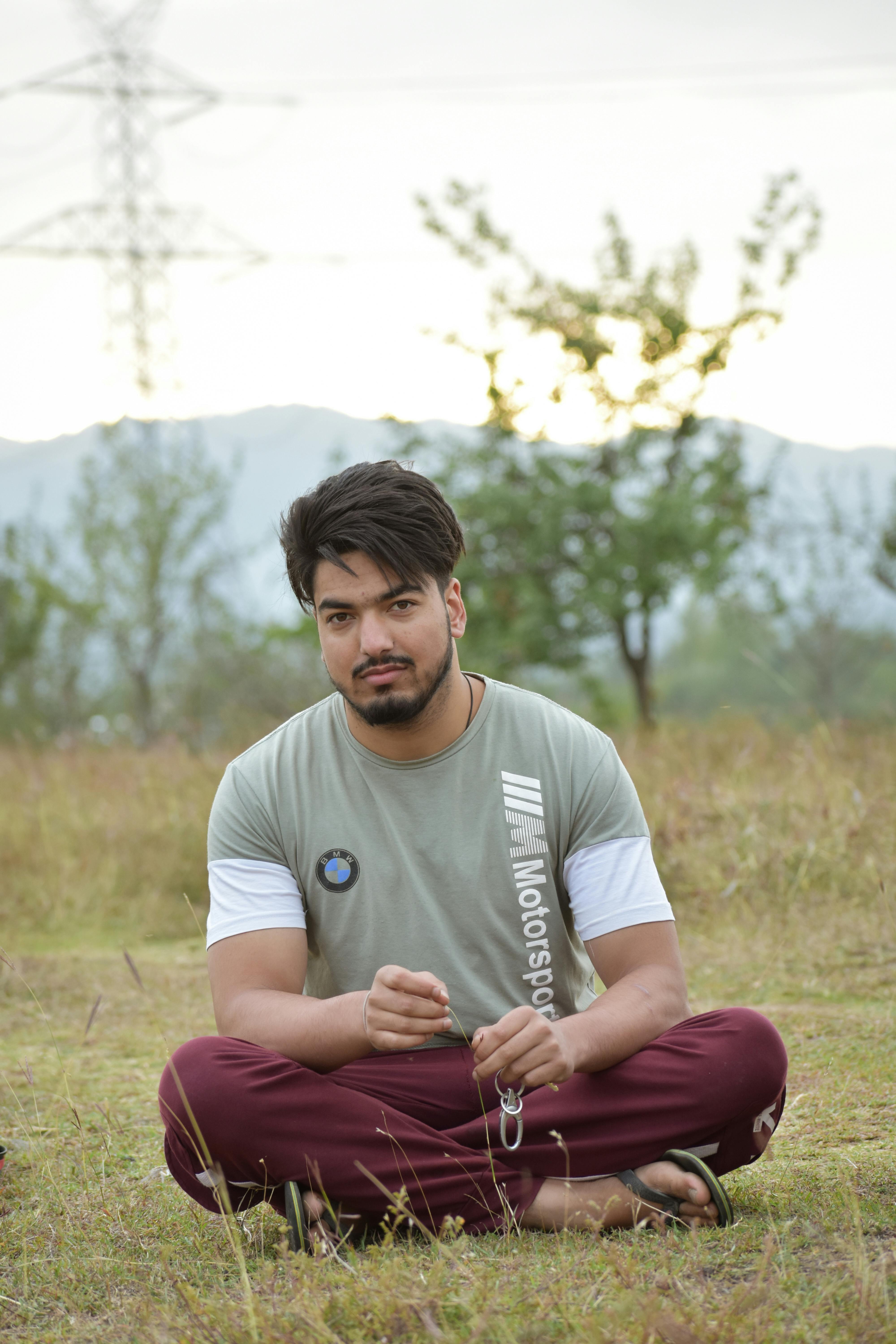 Young Man Sitting Outdoors · Free Stock Photo
