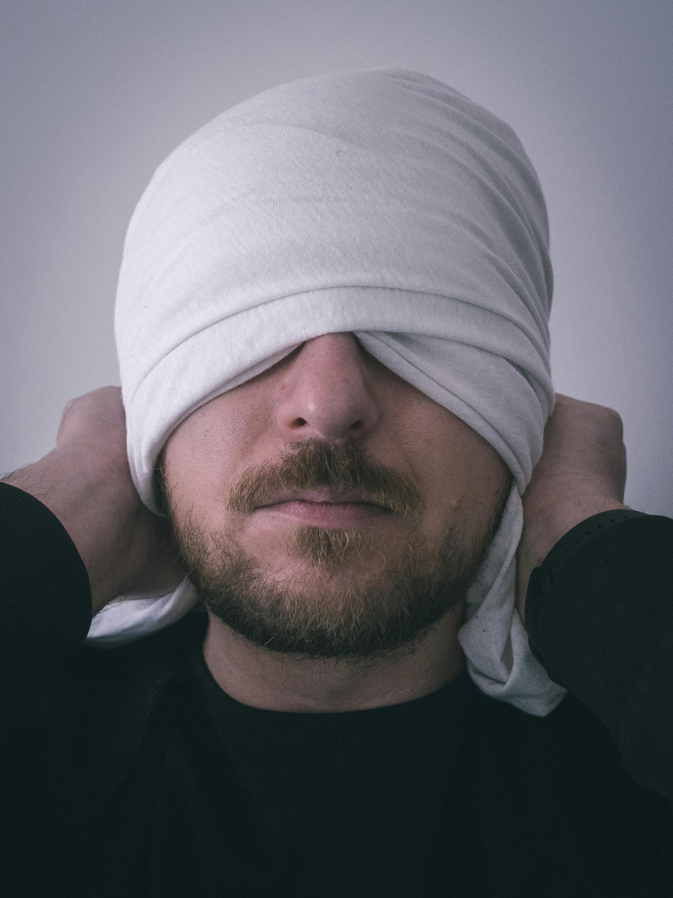Man Covering His Face with His Coat · Free Stock Photo