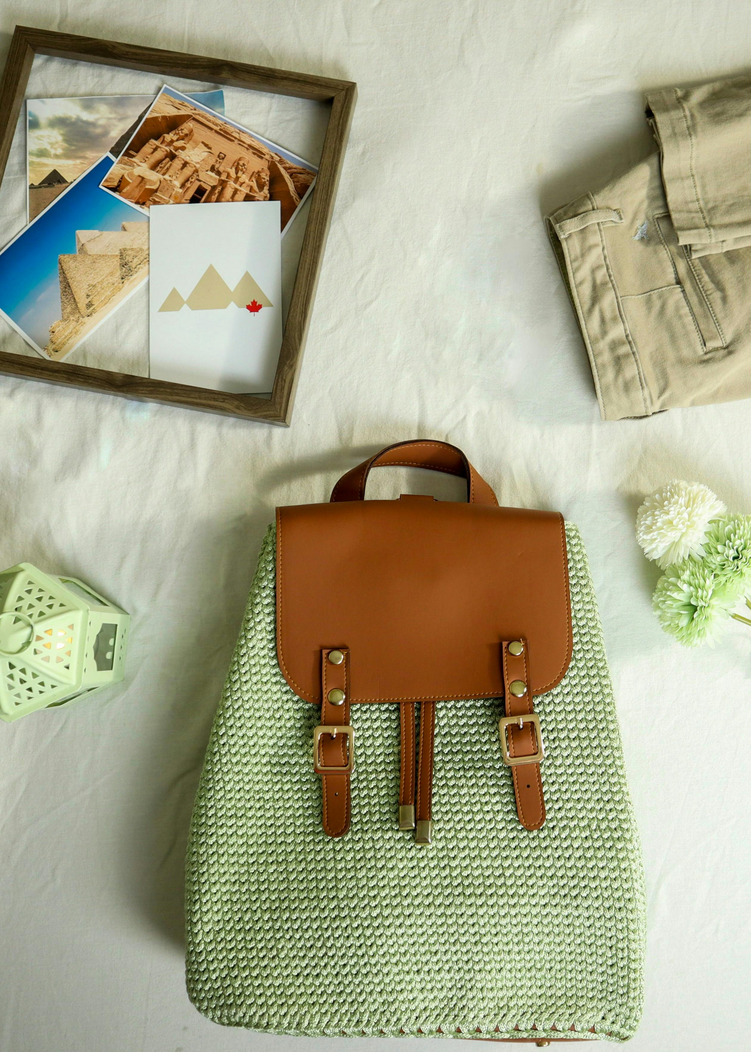 A Backpack and Photographs · Free Stock Photo