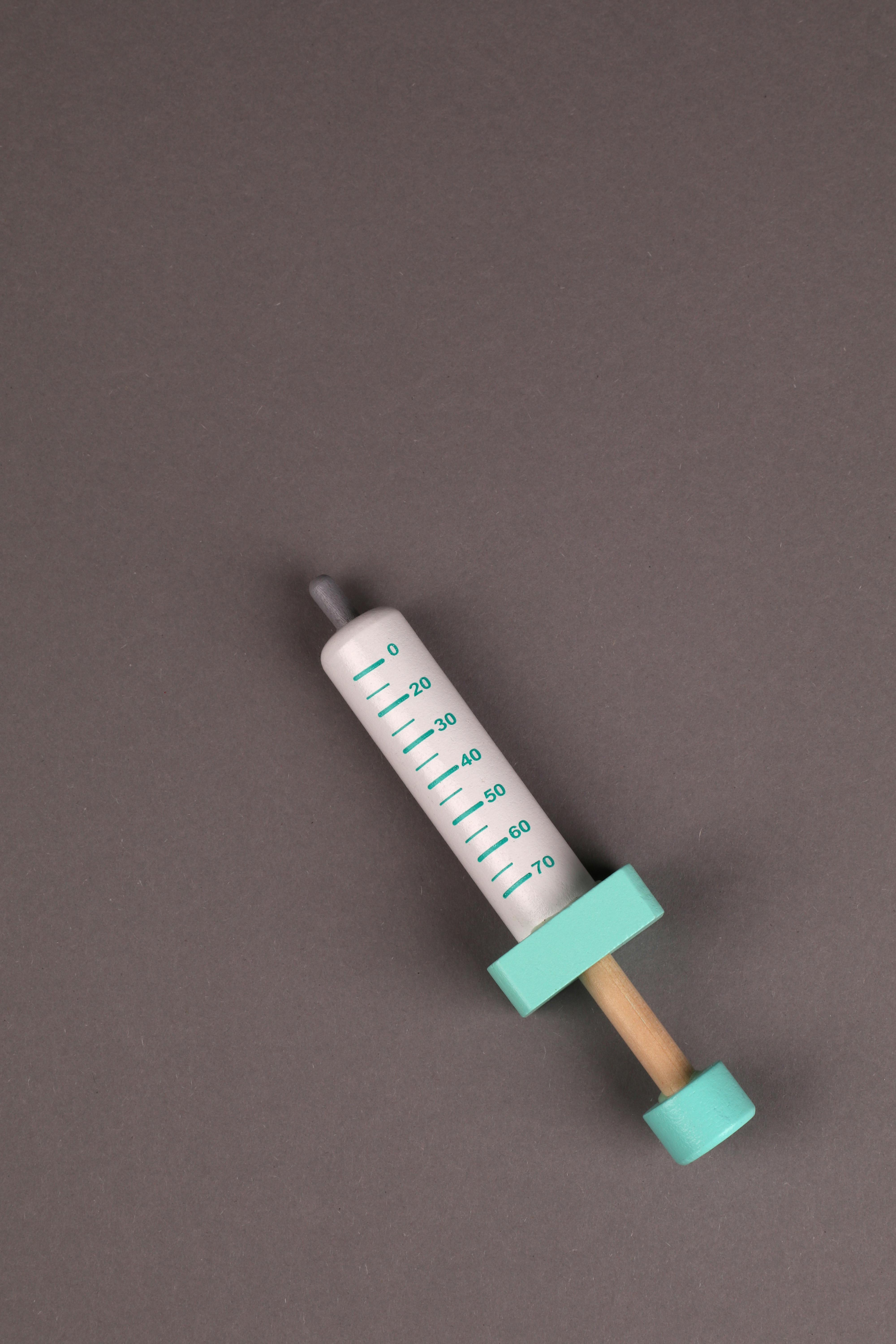 Children Toy Syringe on Grey Background · Free Stock Photo