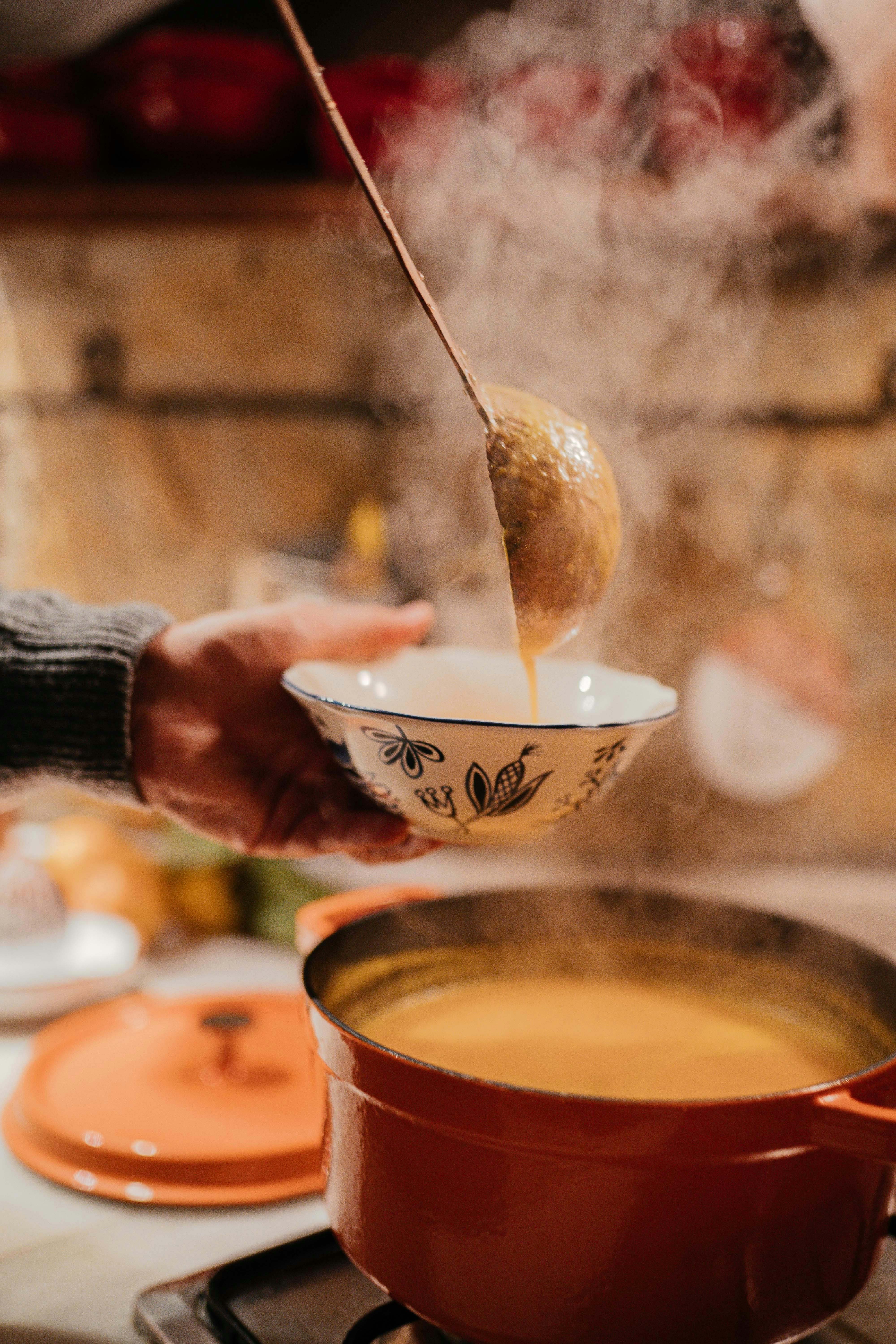 Cloe-up of a Man Pouring Soup into a Bowl · Free Stock Photo