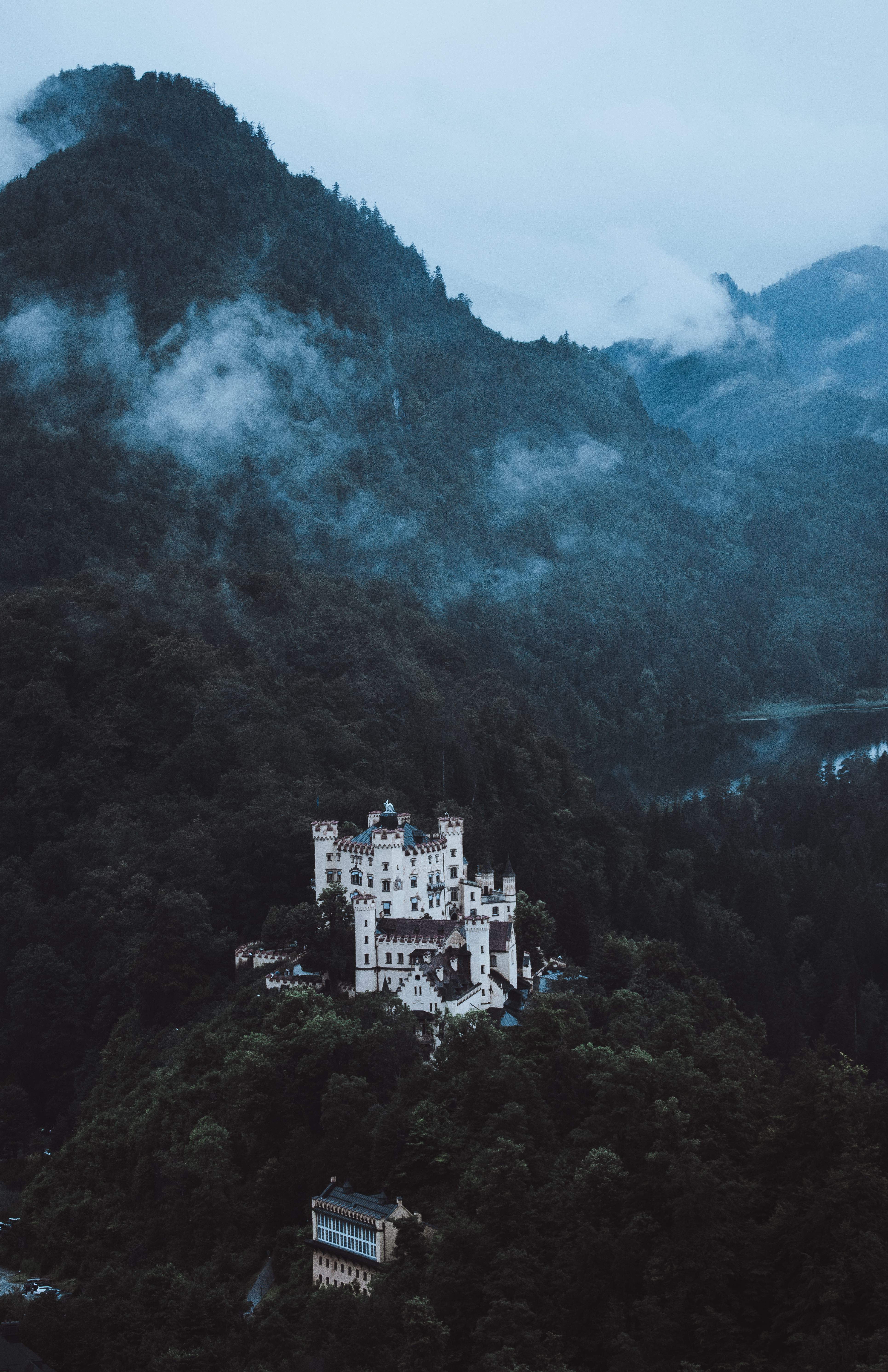 White and Black Concrete Castle Surrounded by Green Trees Under Blue ...