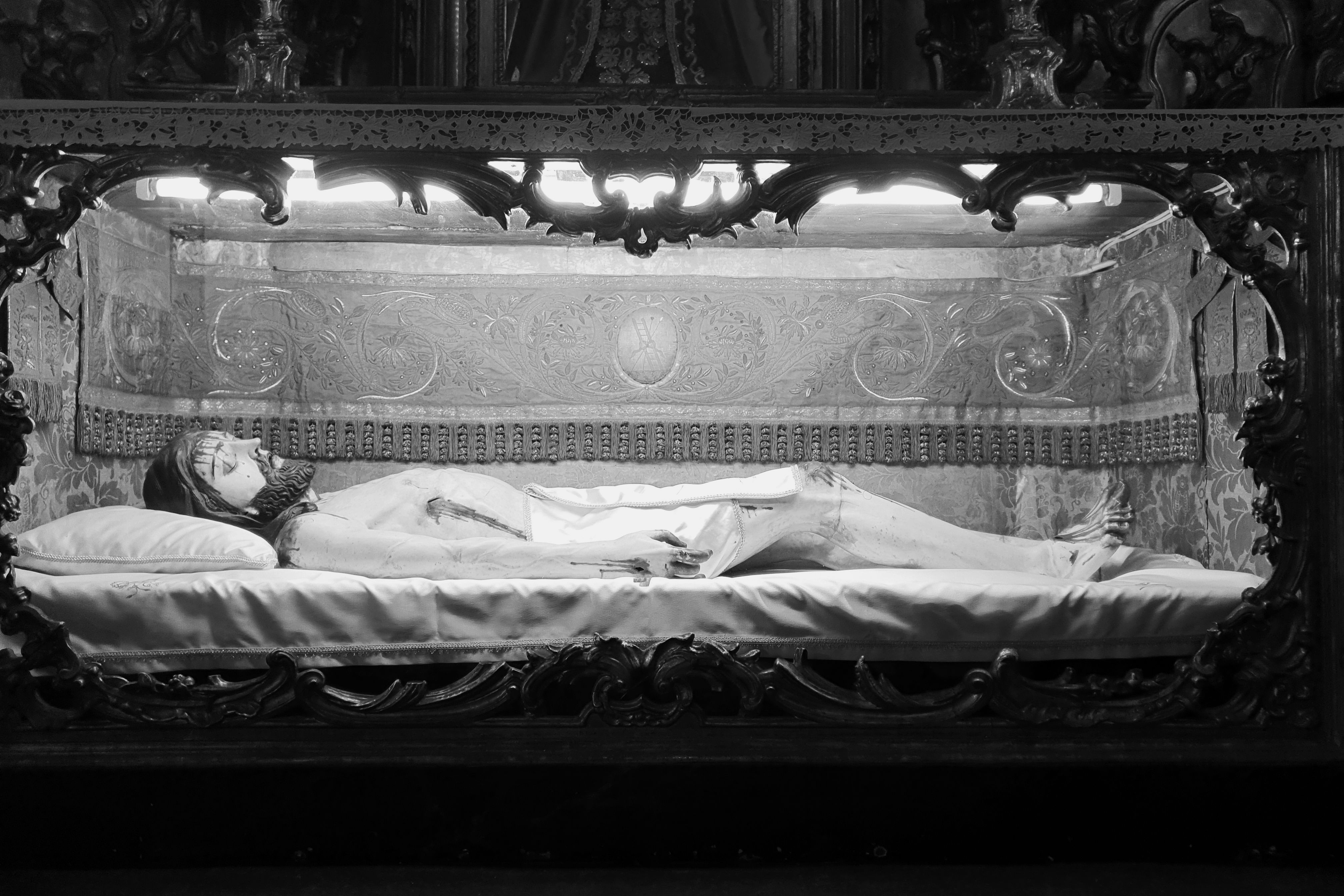 Black and White Photo of Statue of Jesus Laying in Glass Coffin · Free ...