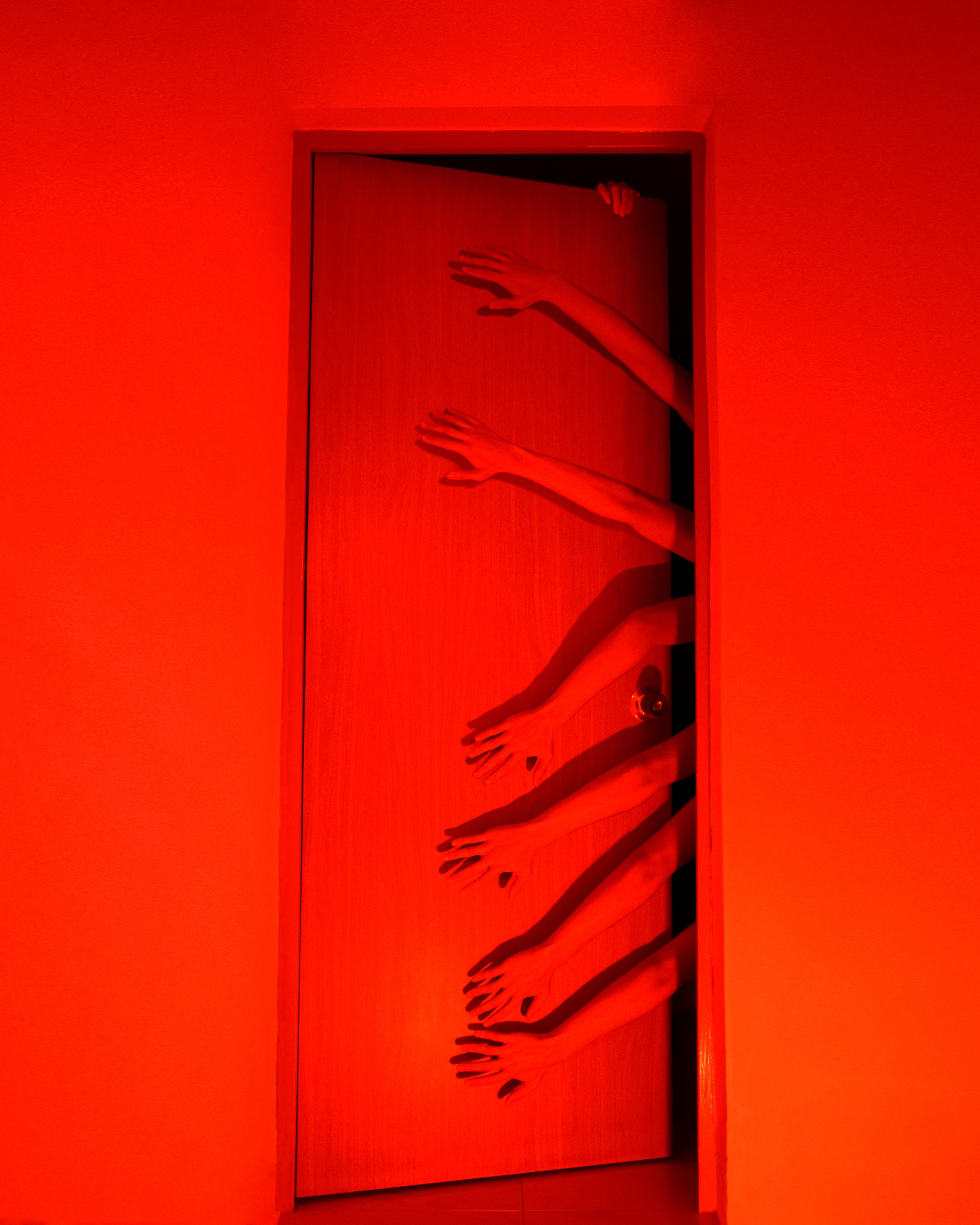 Human Hands and Arms on a Wooden Door · Free Stock Photo