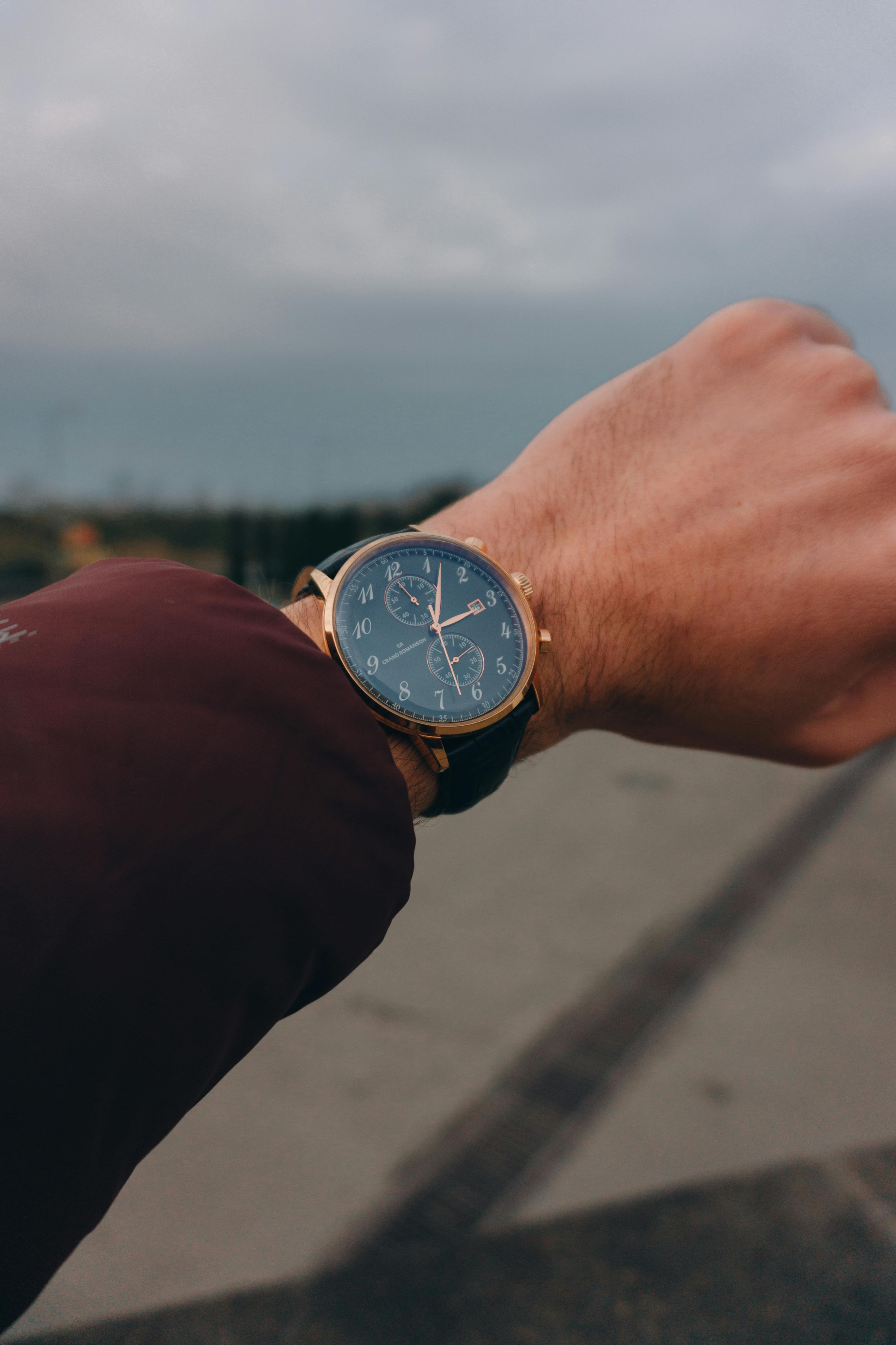 A Person Wearing Round Analog Watch · Free Stock Photo