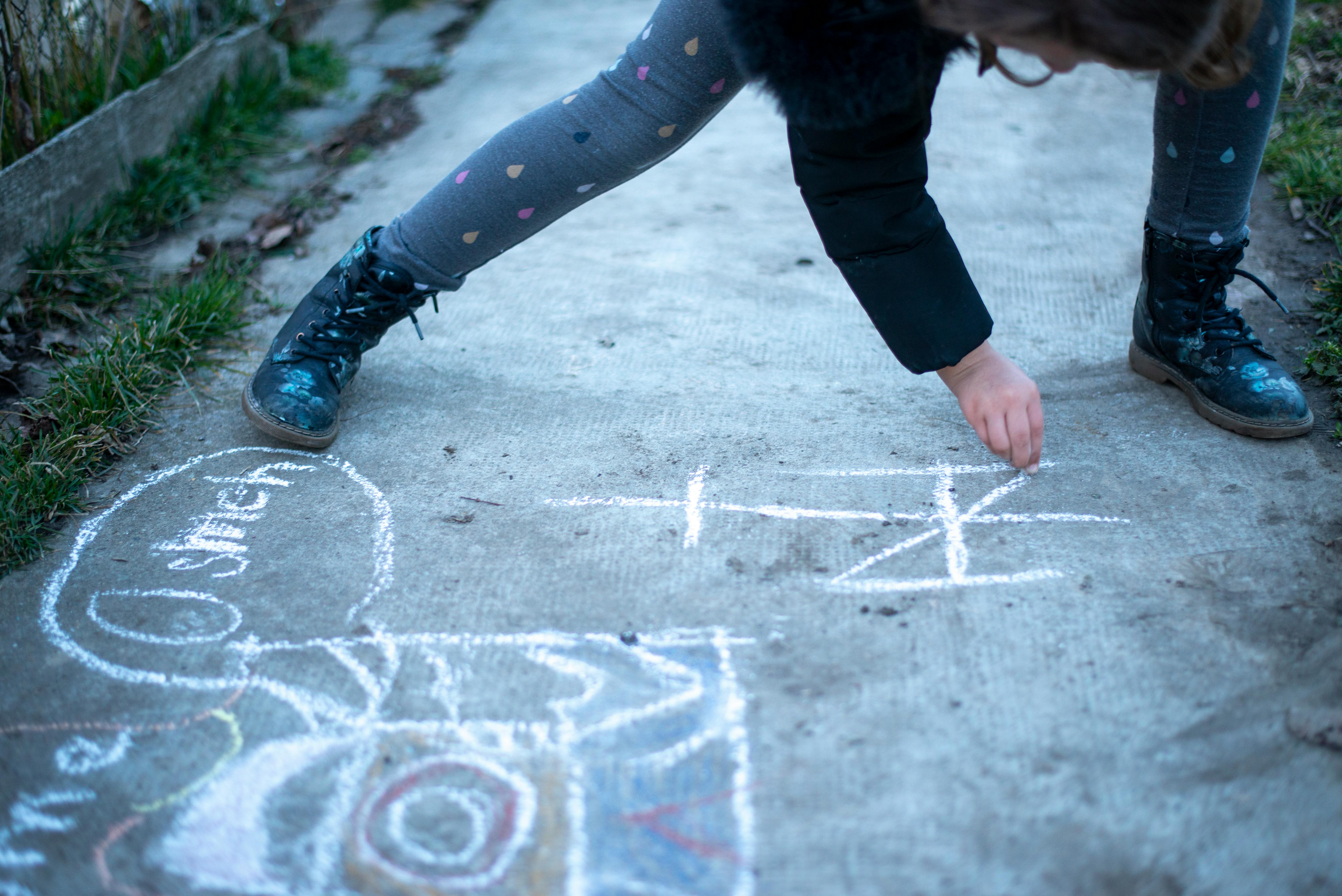 Person Writing on Concrete Floor · Free Stock Photo