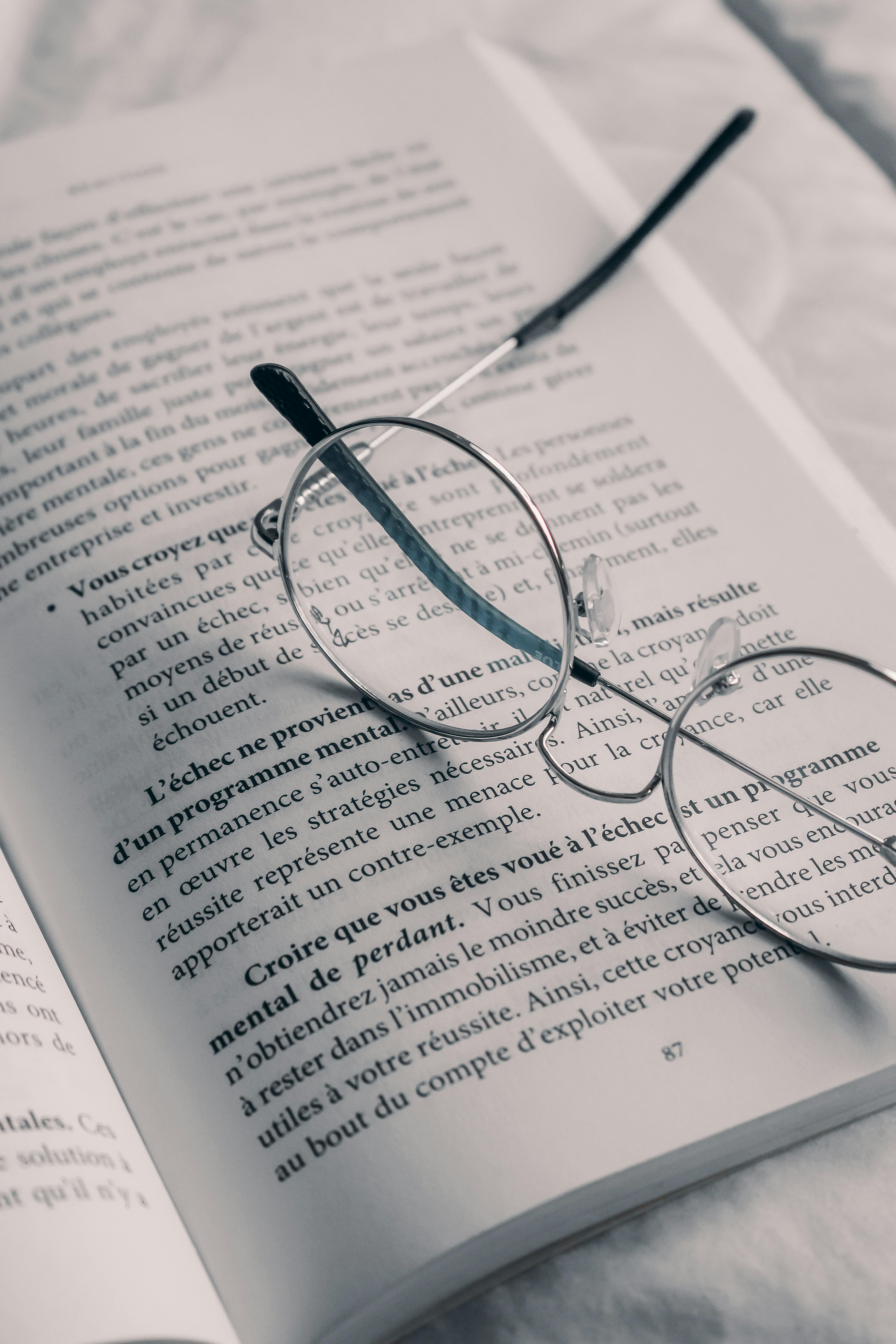 Eyeglasses on Top of a Book · Free Stock Photo