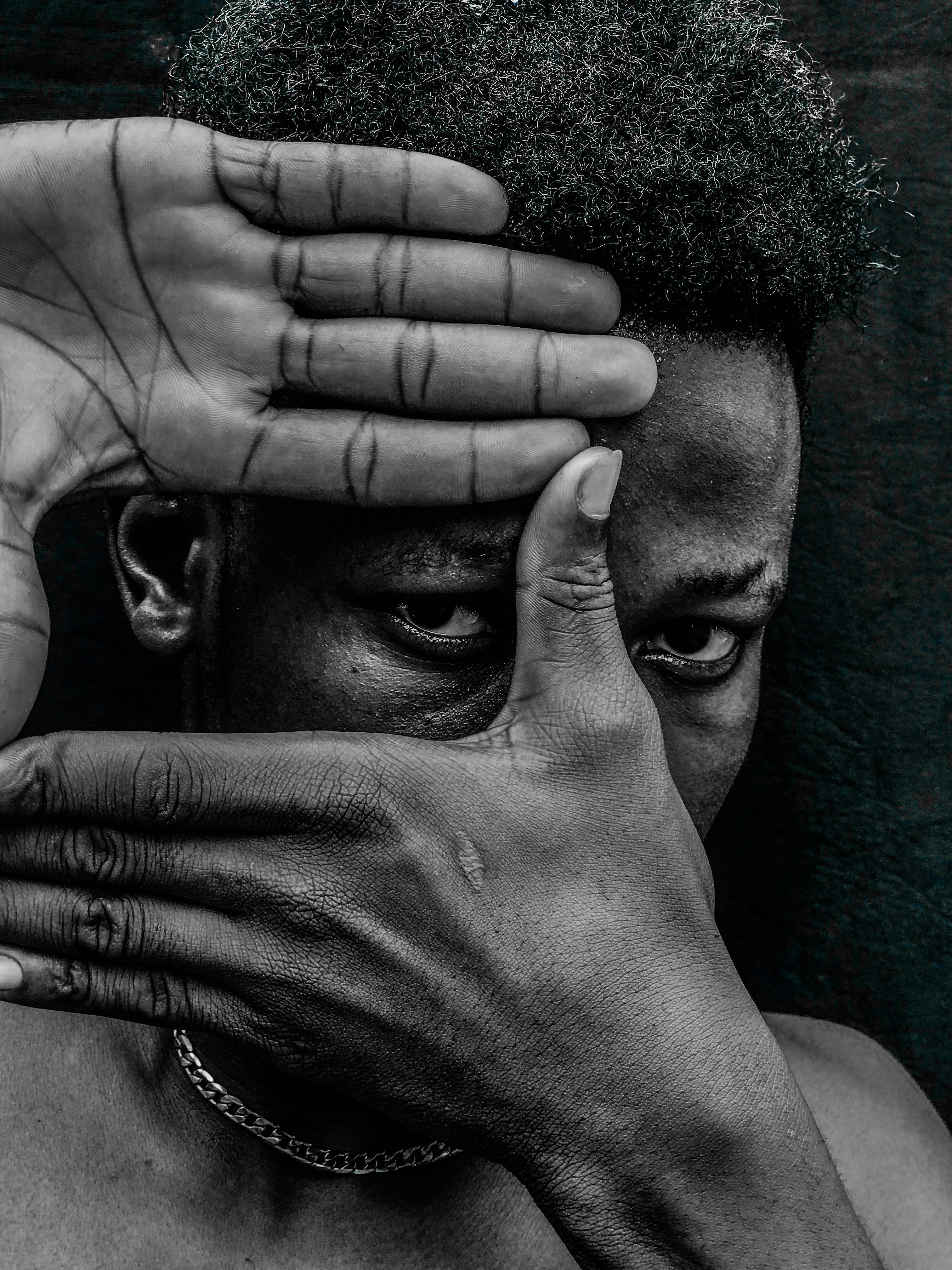 A Grayscale of a Man Making a Frame with His Hand · Free Stock Photo