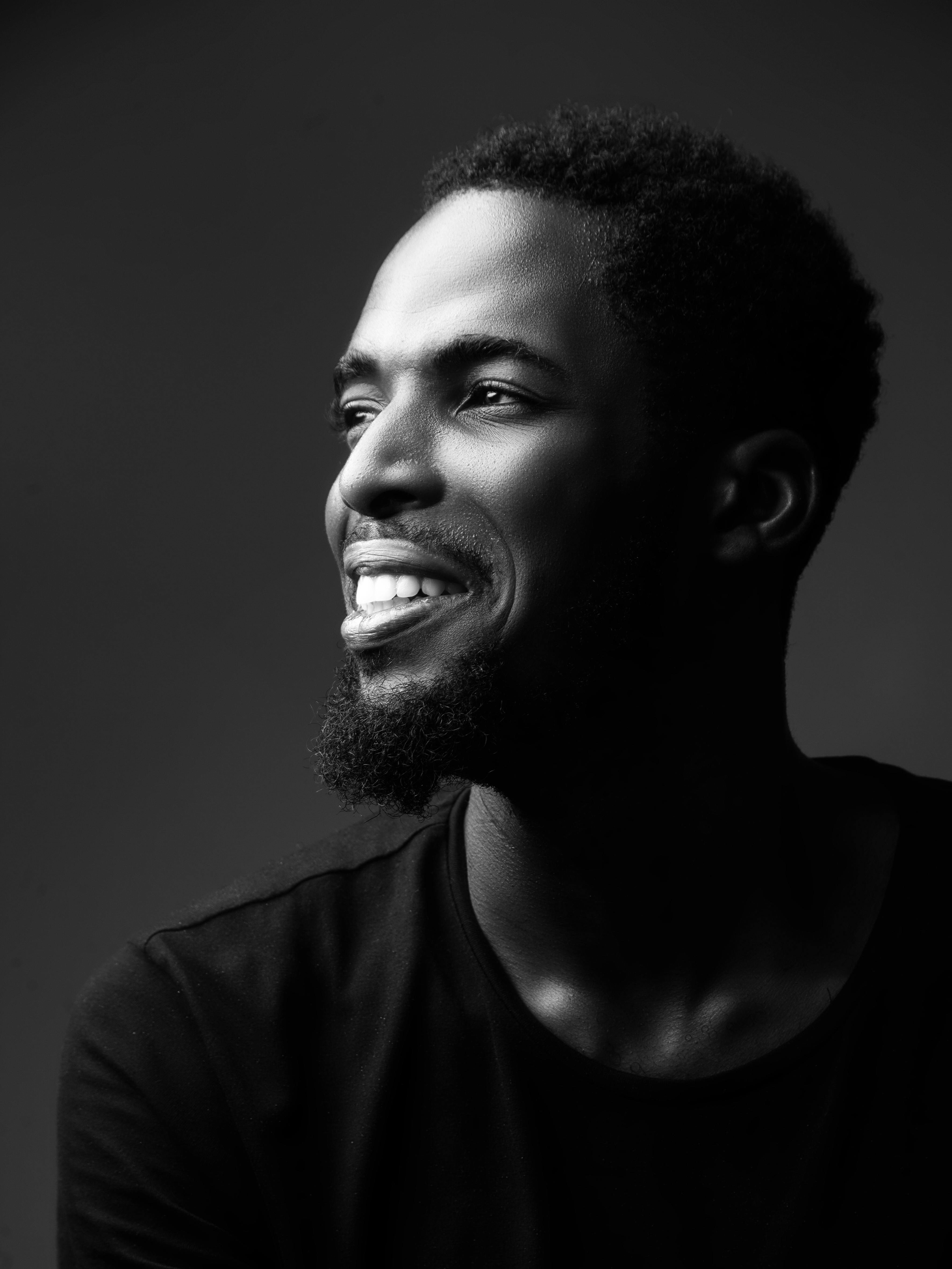 A Grayscale Photo of a Man Showing His Middle Fingers · Free Stock Photo