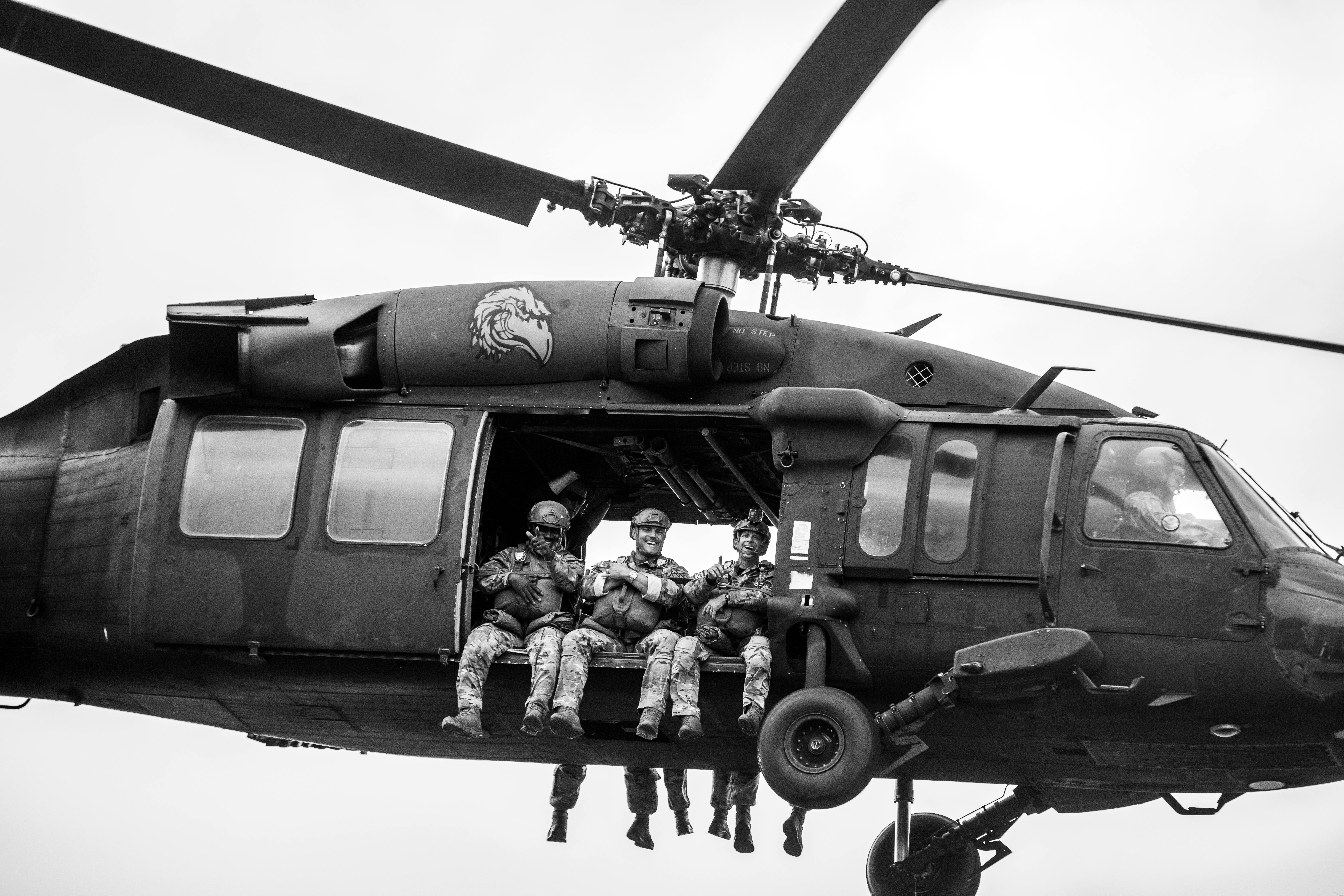 A Grayscale of Soldiers Riding a Utility Helicopter · Free Stock Photo