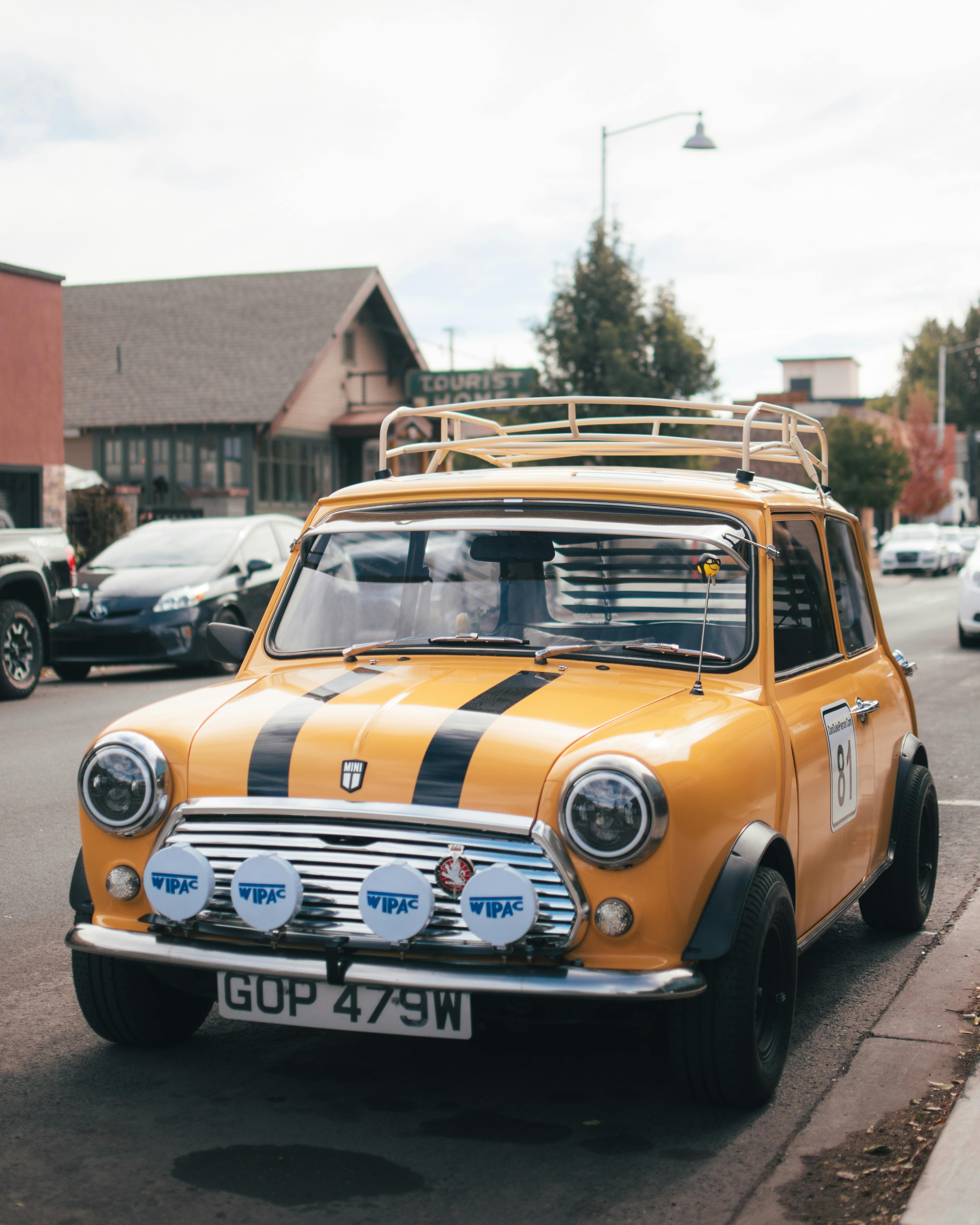 Black and Yellow Vintage Car on Road · Free Stock Photo
