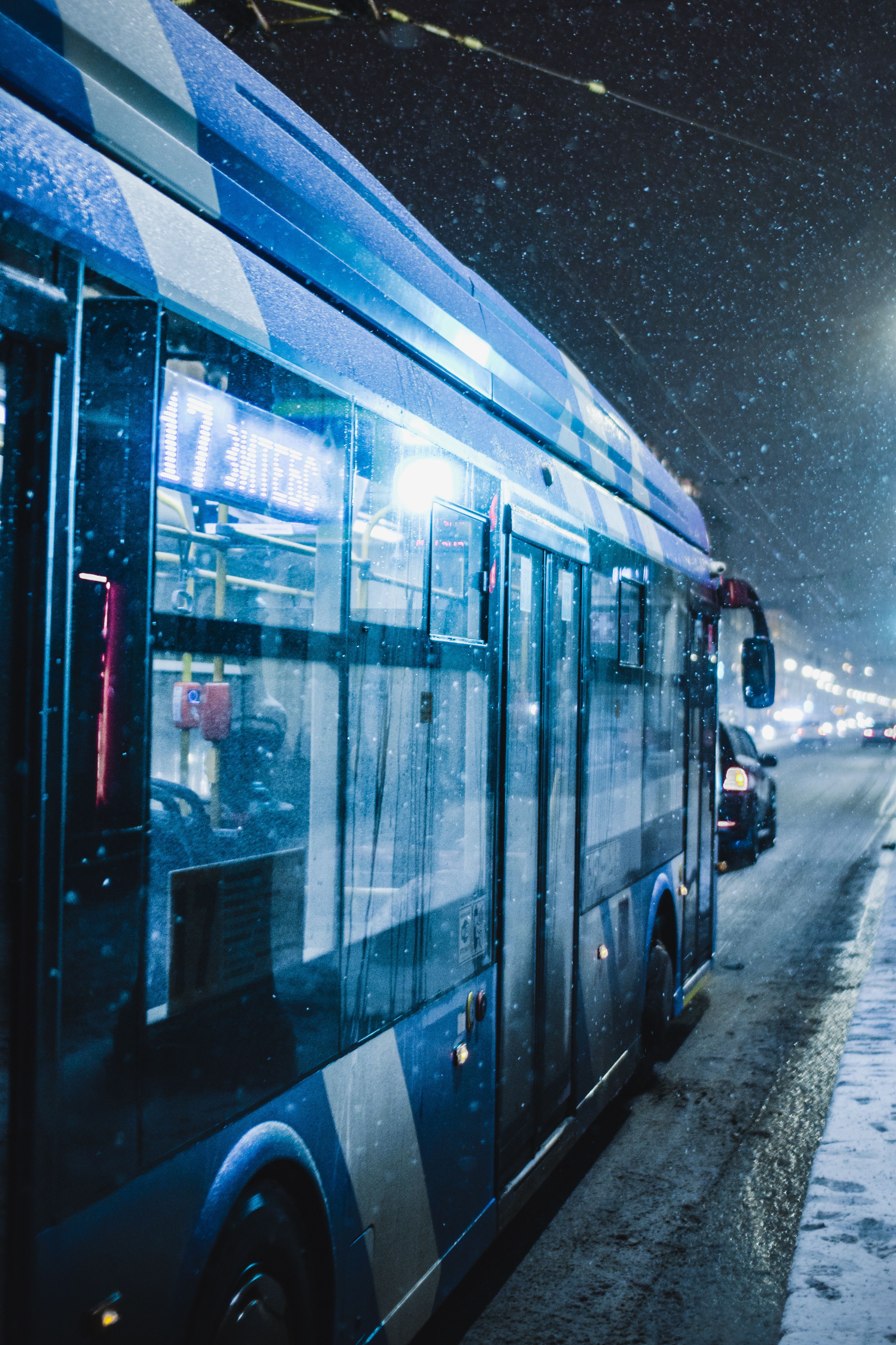 Blue Bus Driving in Snowy Weather · Free Stock Photo