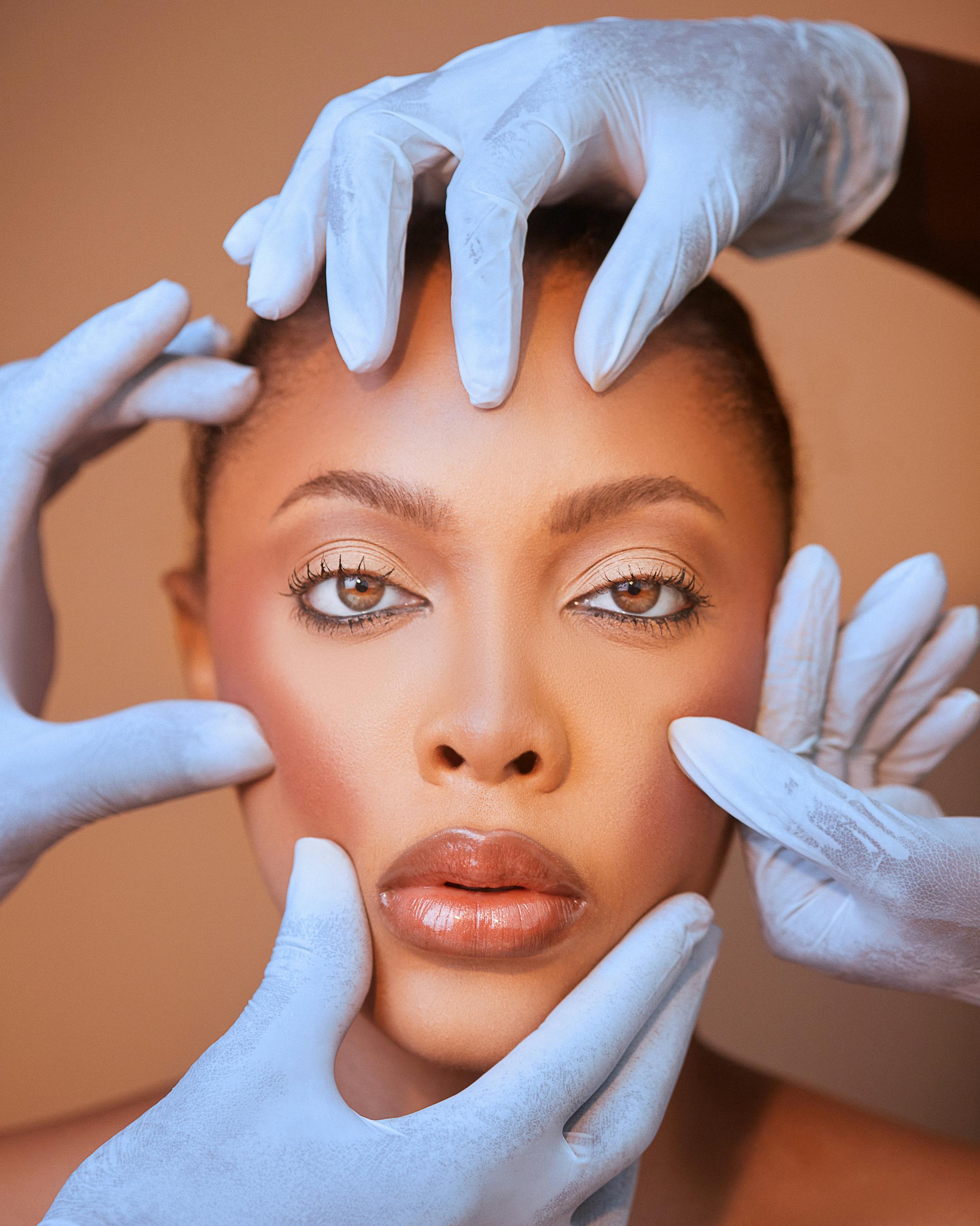 People Wearing Gloves Touching a Woman's Face · Free Stock Photo