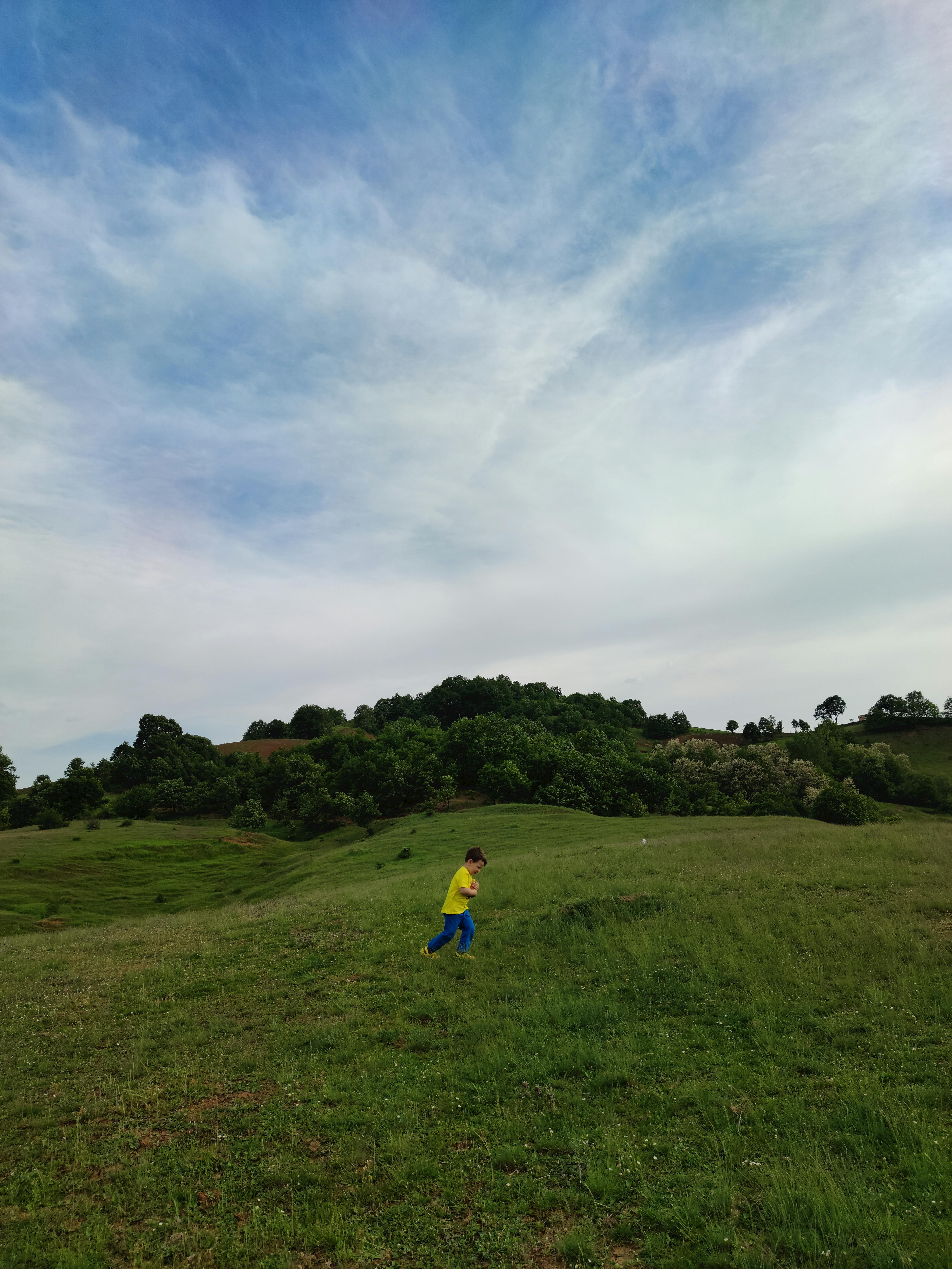 A Kid Running on the Grass Field · Free Stock Photo