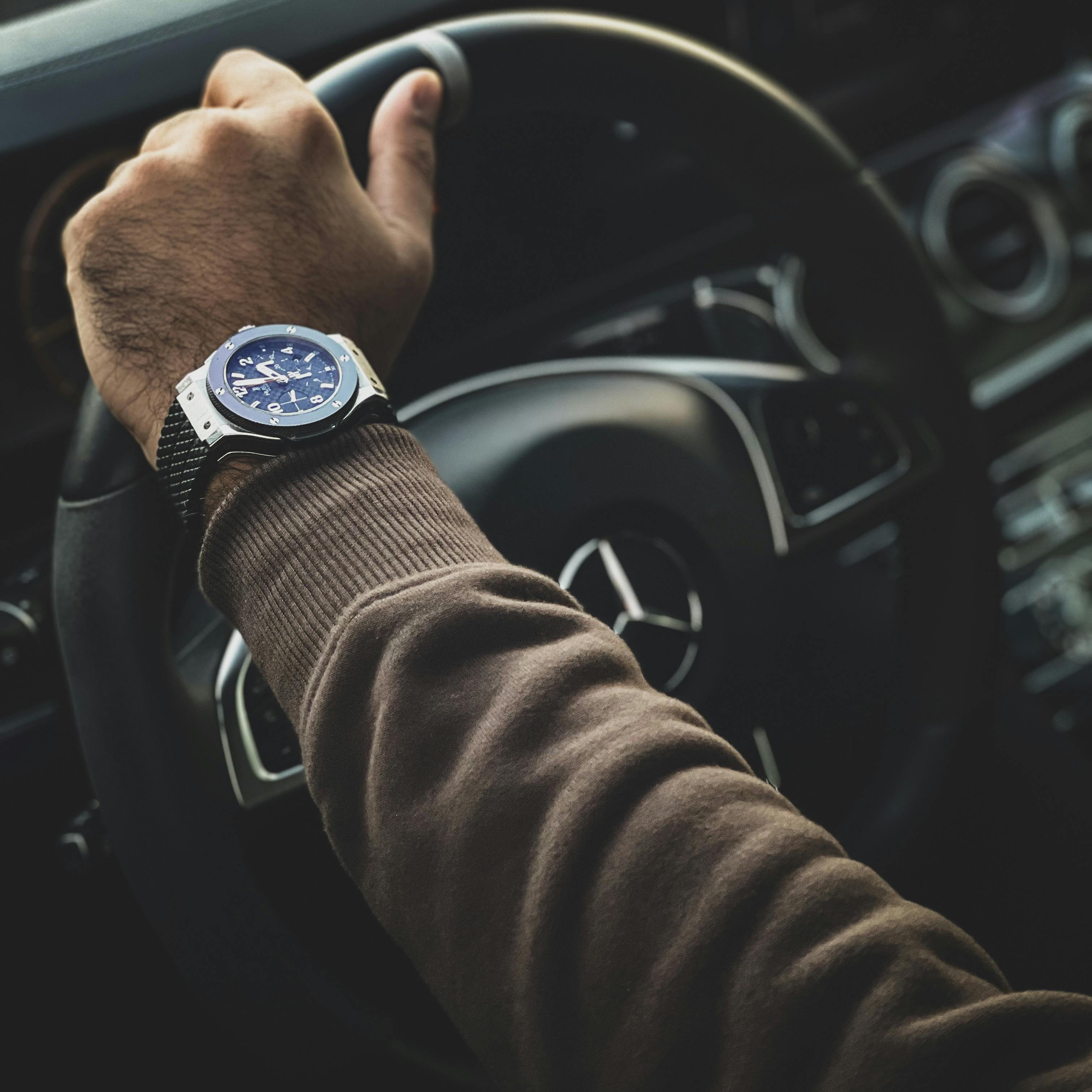 Person Wearing Round White Analog Watch Black Strap Holding on Vehicle ...