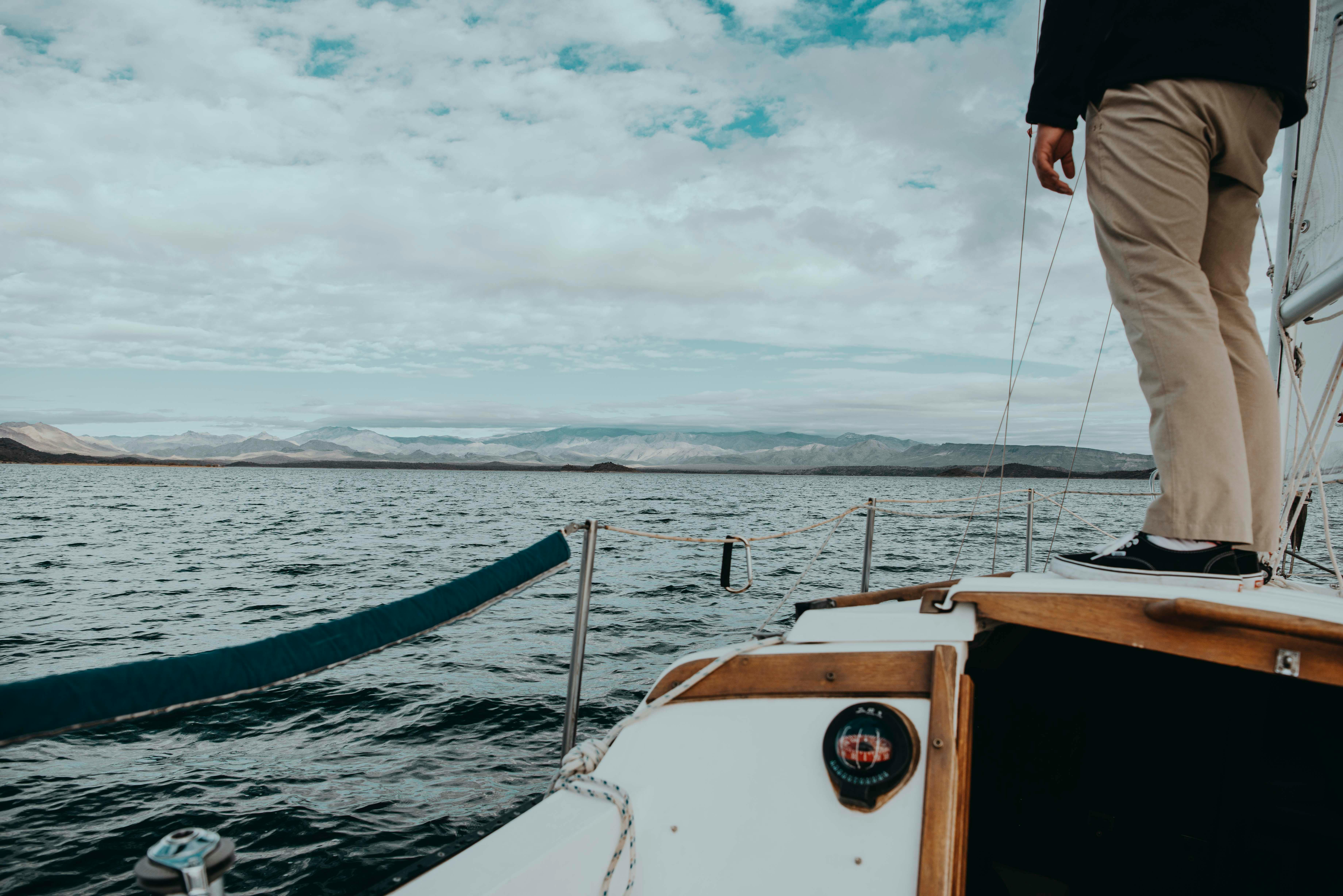 Person Standing in the Boat While Sailing in the Sea · Free Stock Photo