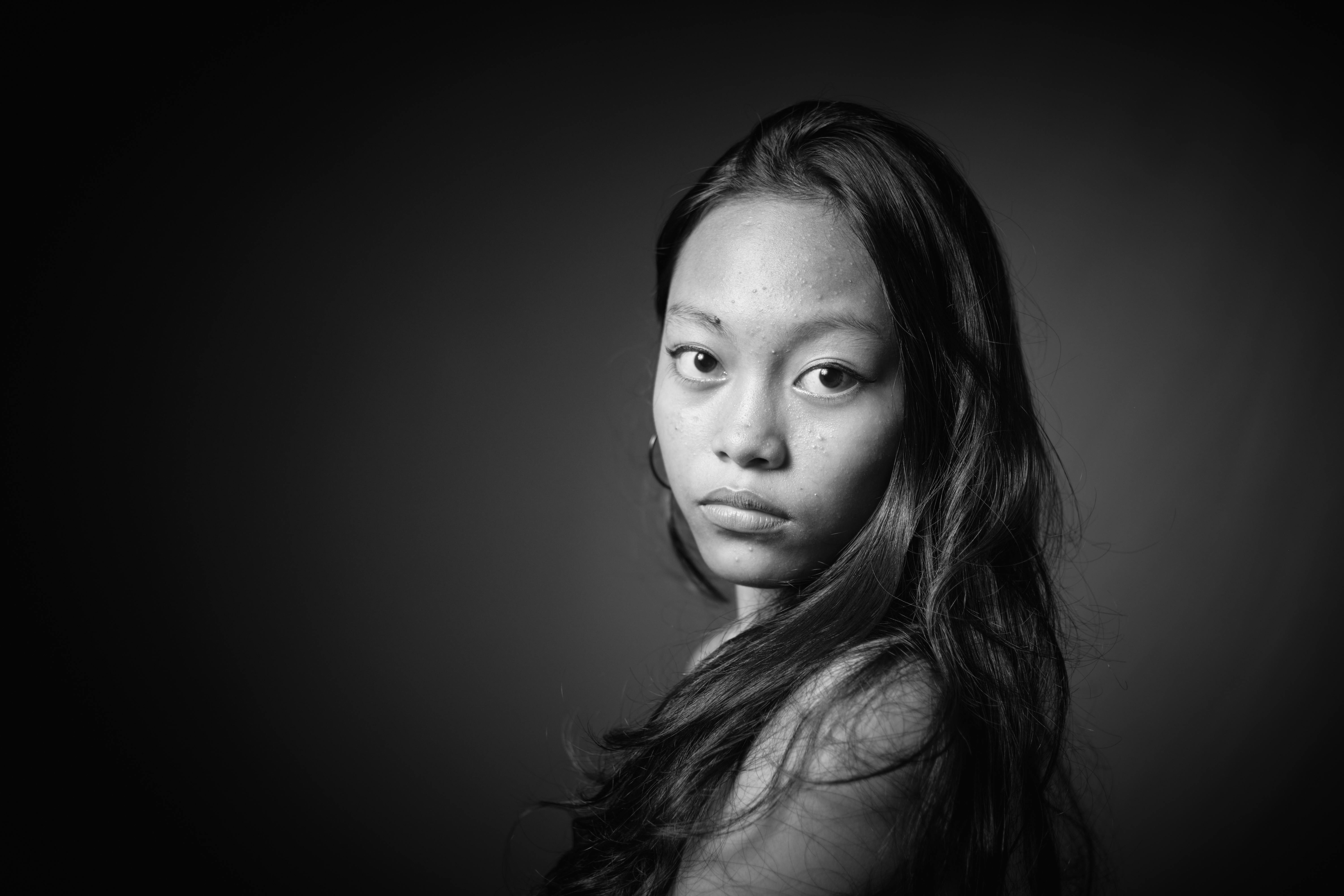 Grayscale Photo of a Kid Looking Over Her Shoulder · Free Stock Photo
