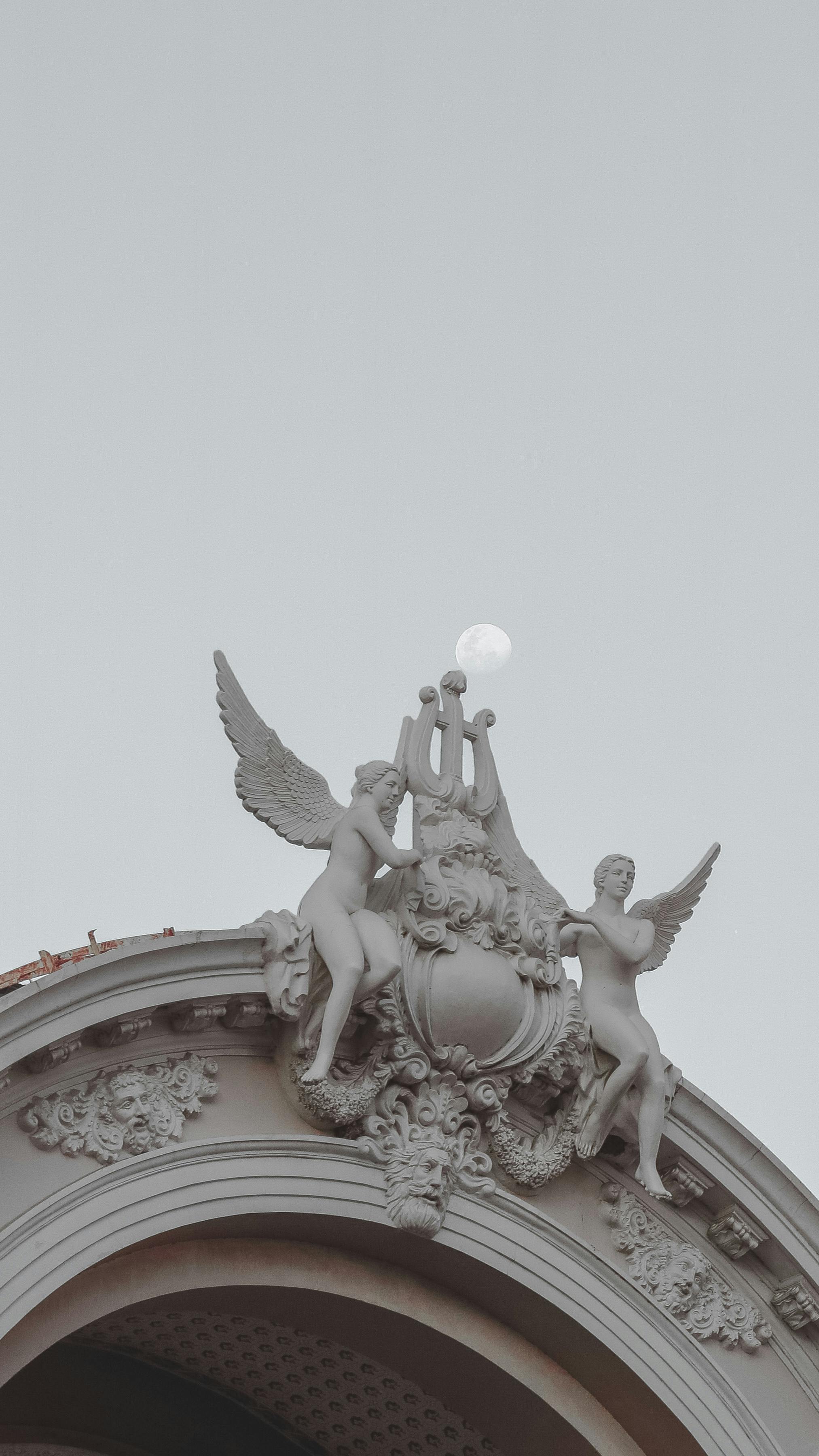 Golden Statues Beside a Window · Free Stock Photo