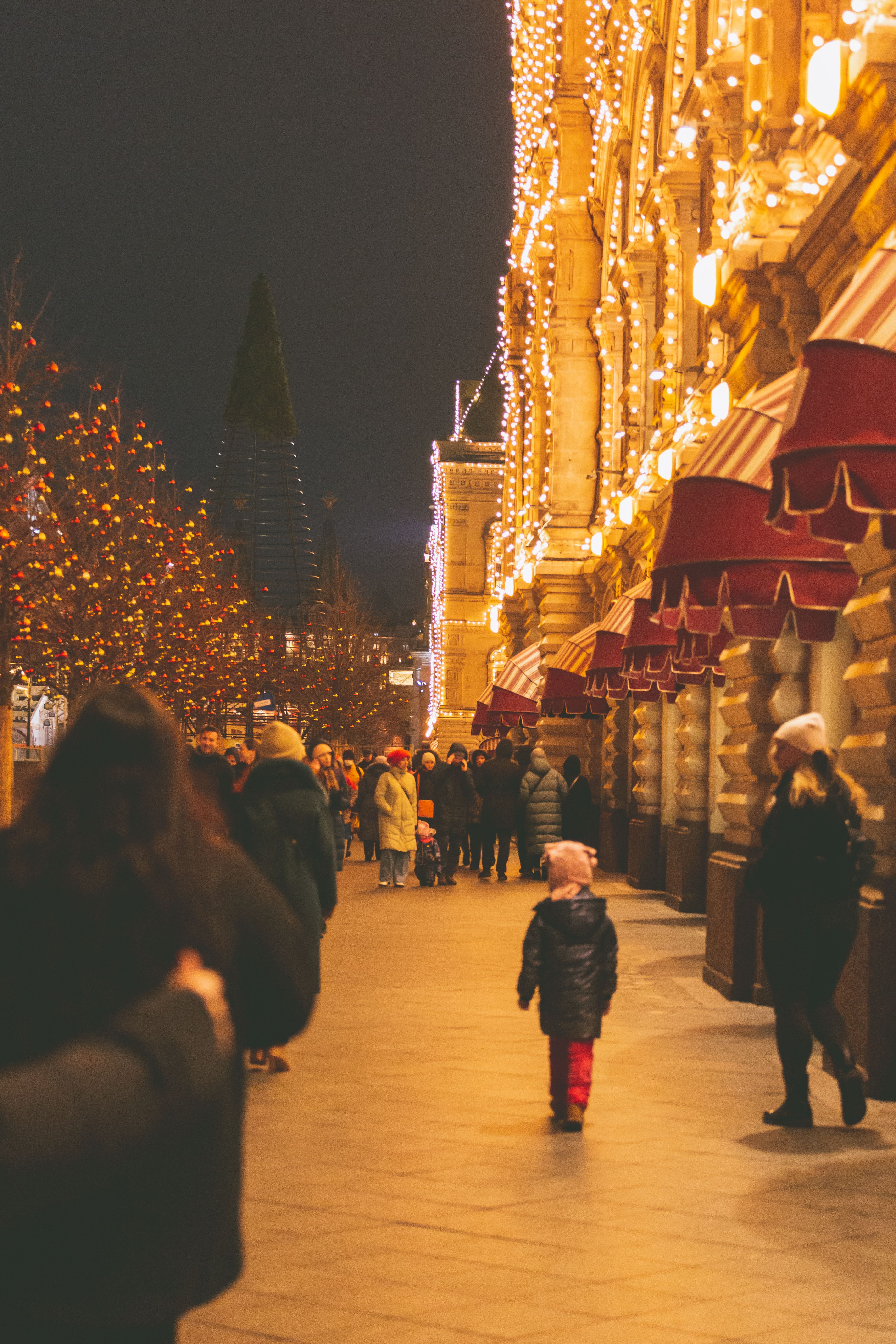People Walking by a Building with Lights · Free Stock Photo