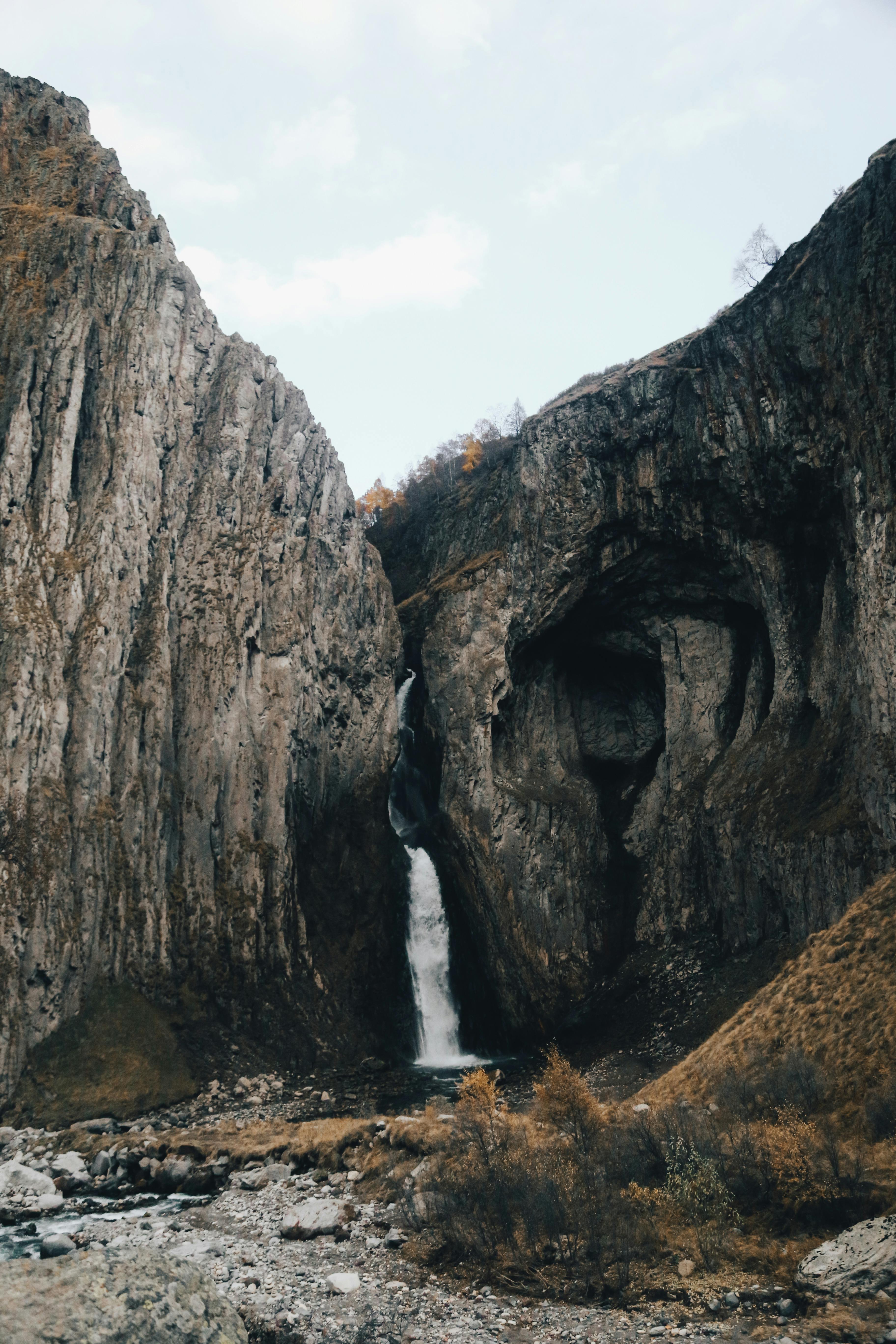 Waterfall in Between Mountains · Free Stock Photo