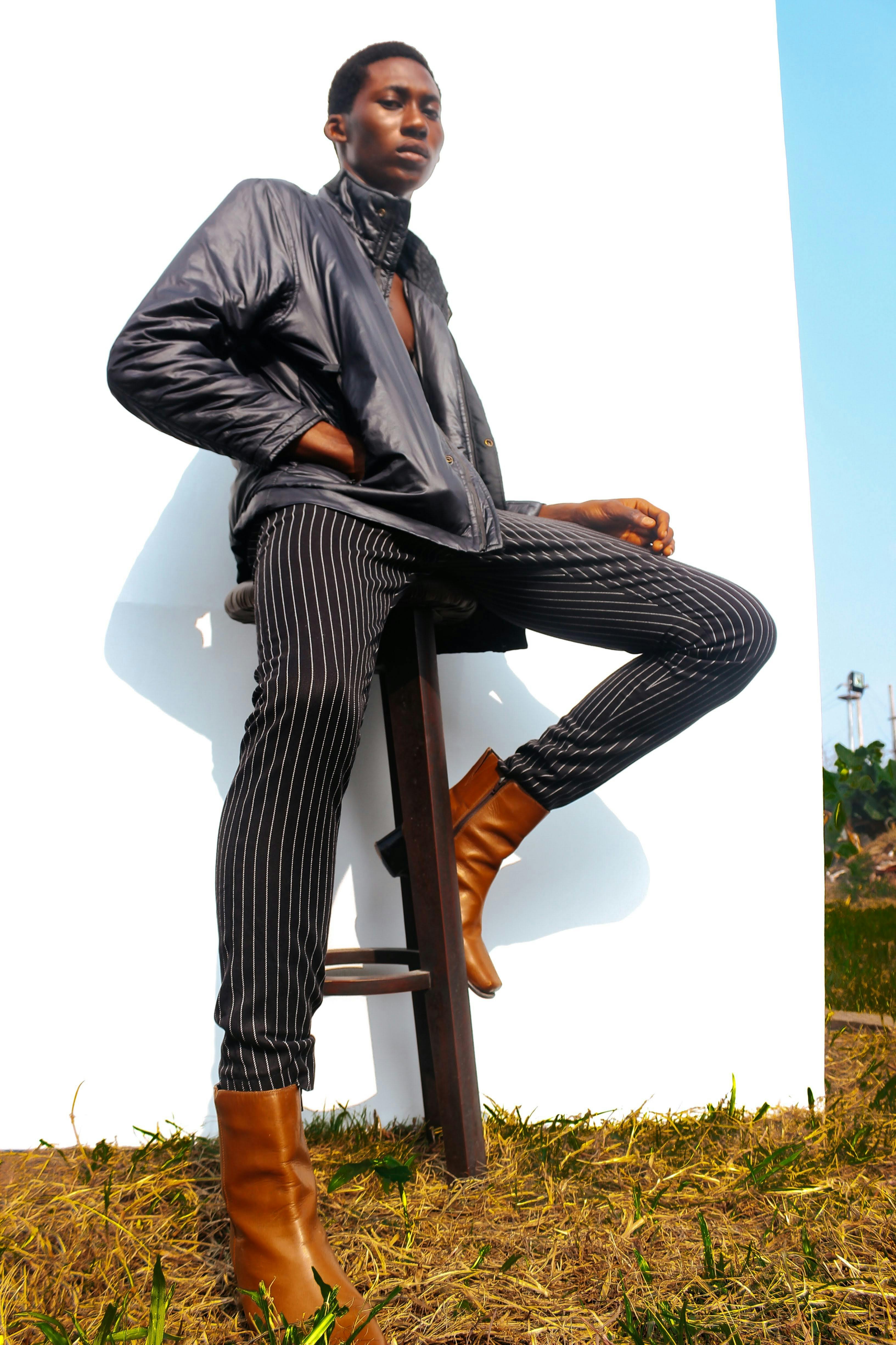 Photo of a Man Sitting on Stool · Free Stock Photo