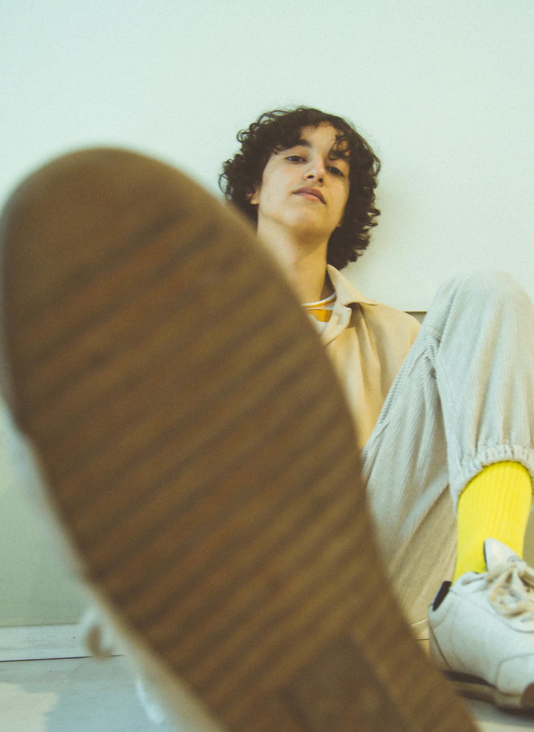 Person Leaning at the Wall While Sitting on the Ground · Free Stock Photo