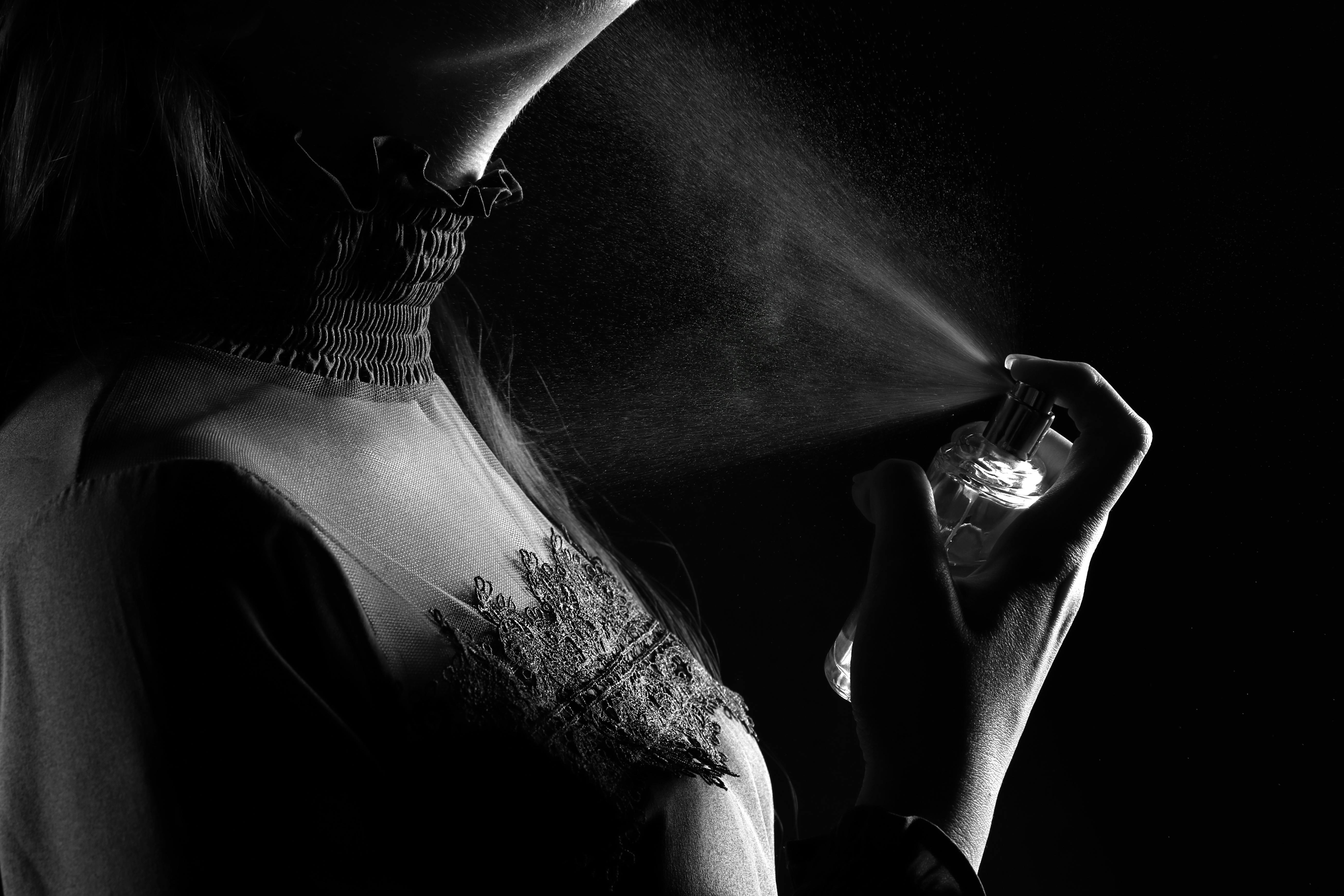 Grayscale Photo of Person Spraying Perfume · Free Stock Photo