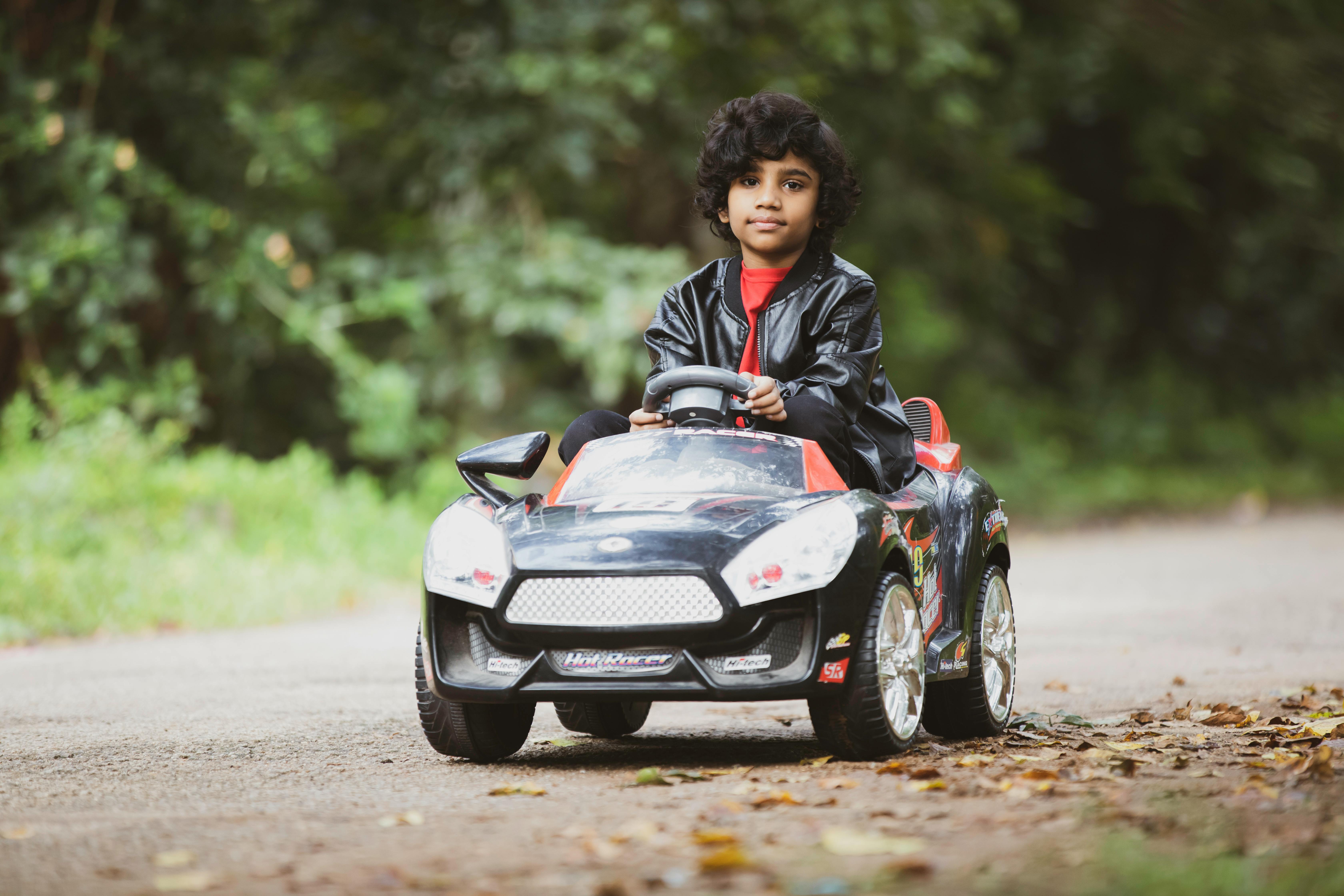 Child Driving a Ride On Toy Car · Free Stock Photo