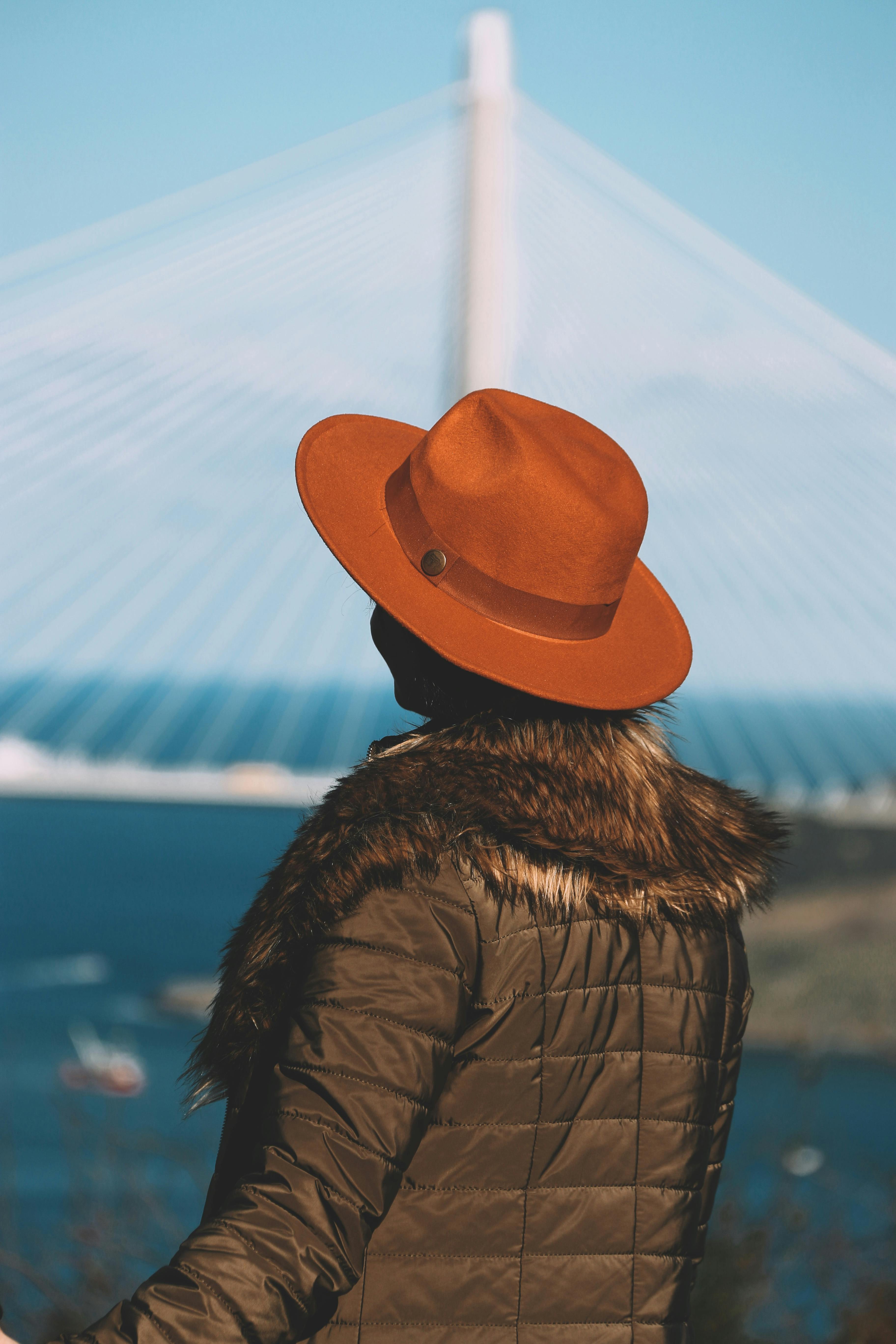 Street Poet in Fedora Hat and Overcoat Sitting at a Table with a ...