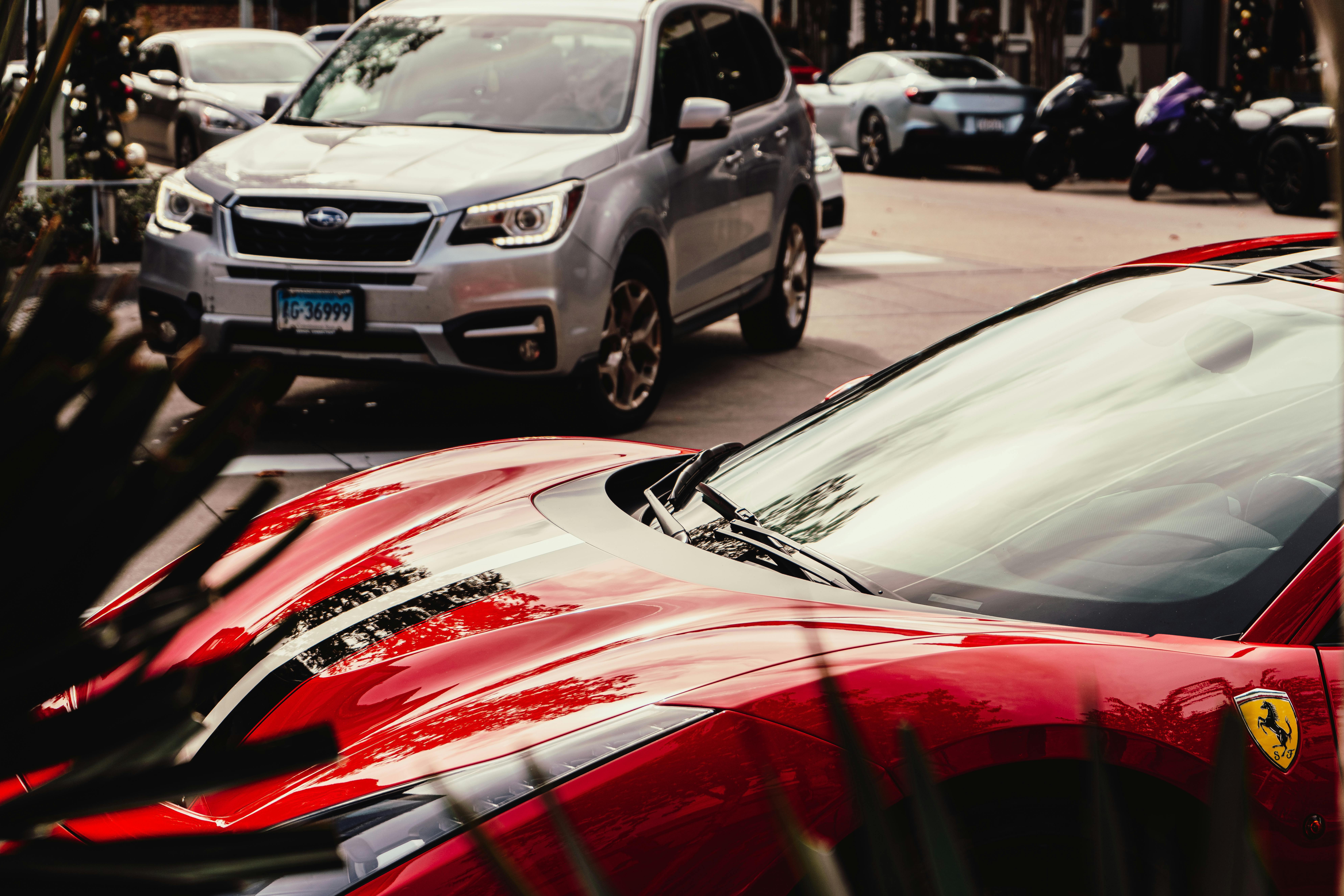 Red Ferrari in a Parkin Lot · Free Stock Photo
