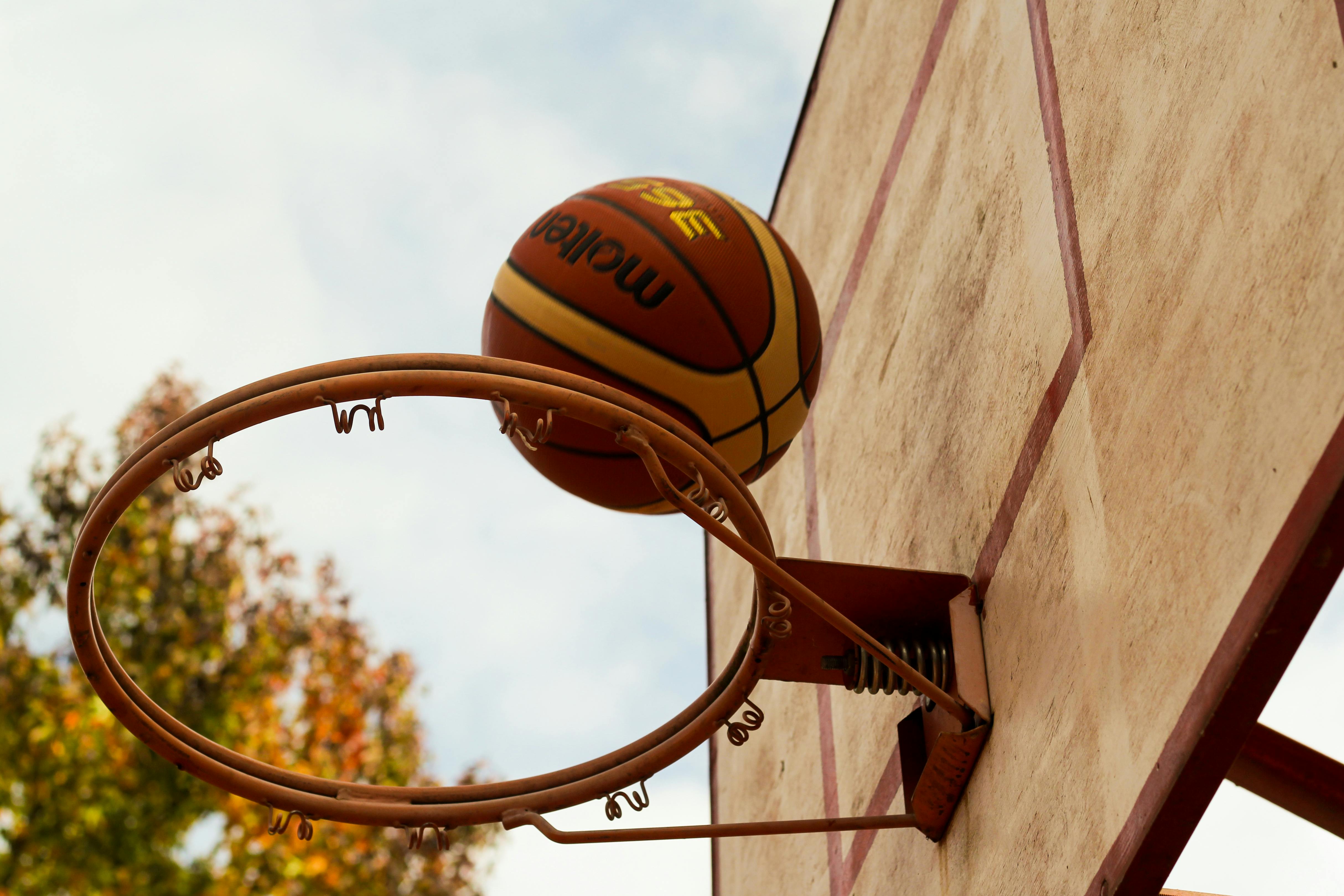 Brown Basketball Above Steel Basketball Hoop · Free Stock Photo