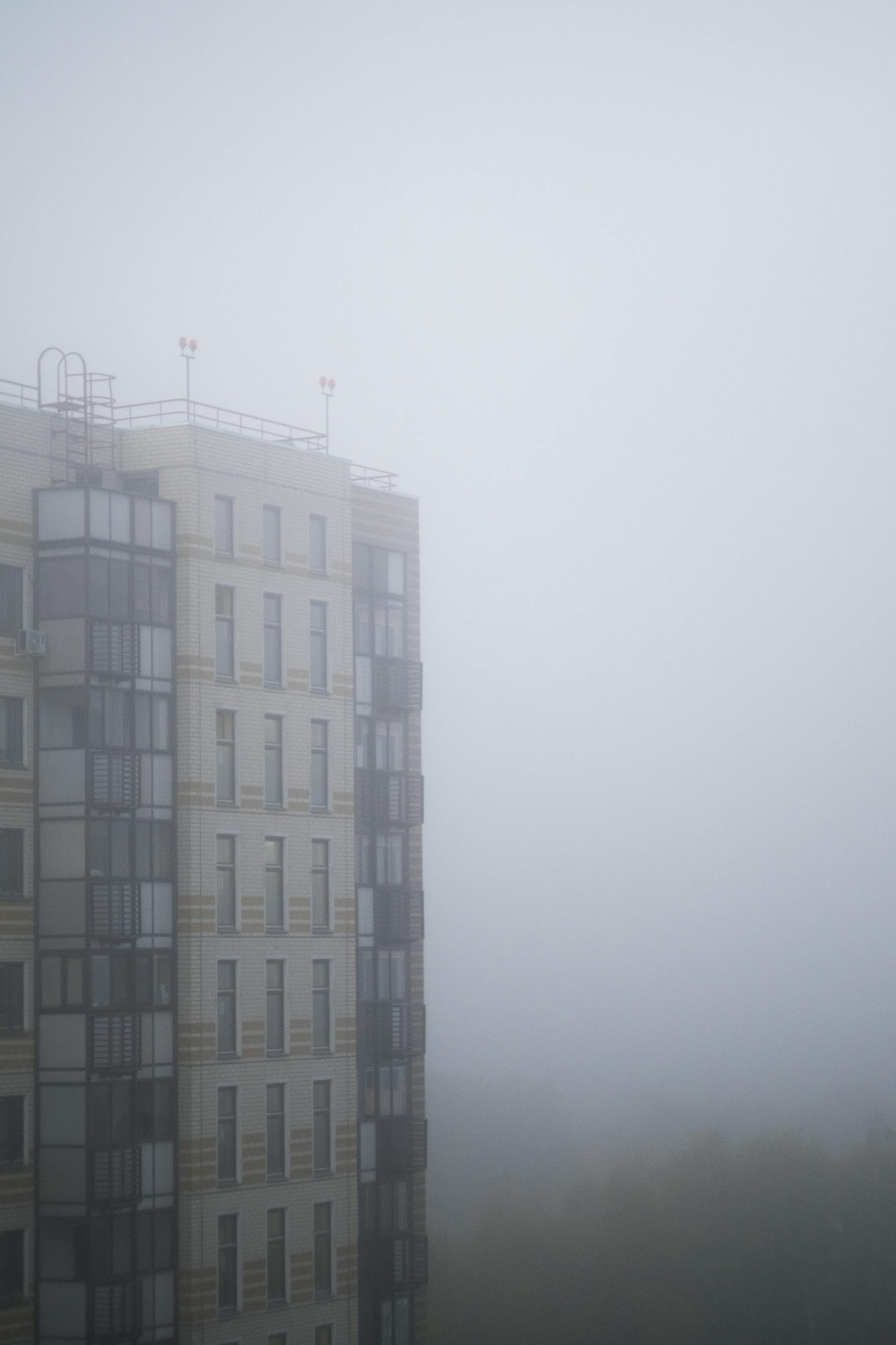 White Concrete Building on a Foggy Sky · Free Stock Photo