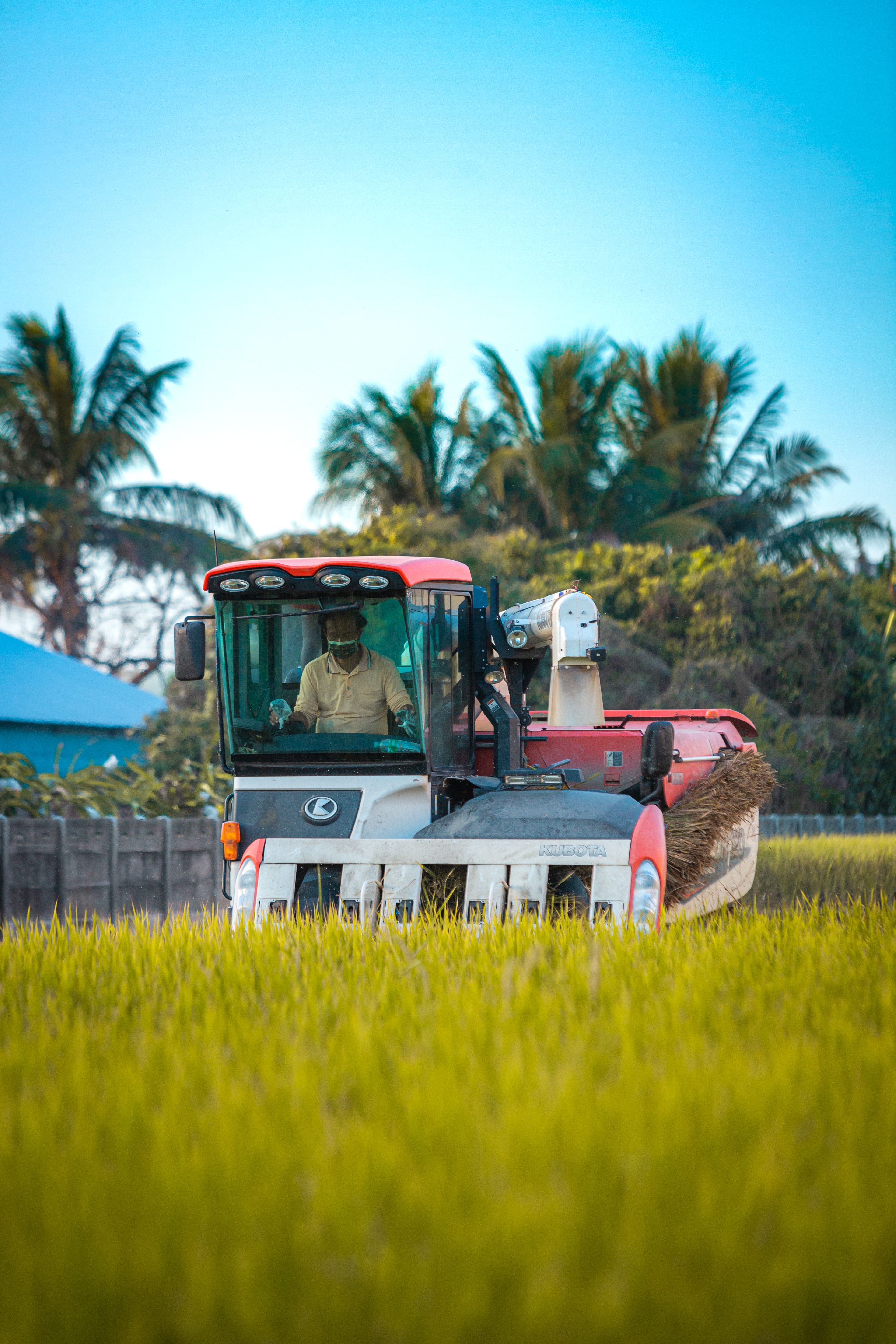 Man Driving a Combine Harvester in a Field · Free Stock Photo