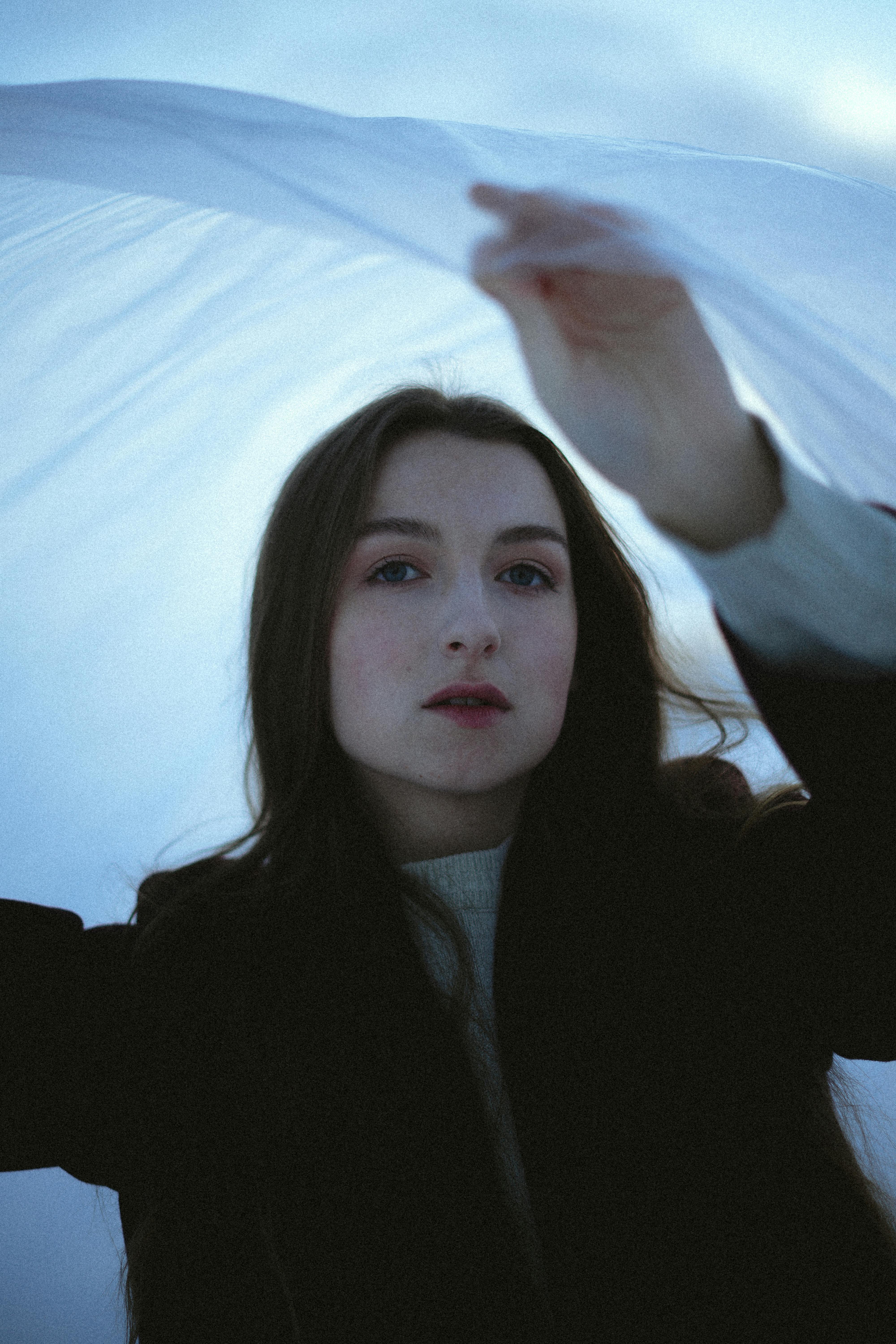 Woman Kneeling Under Sheer Fabric · Free Stock Photo