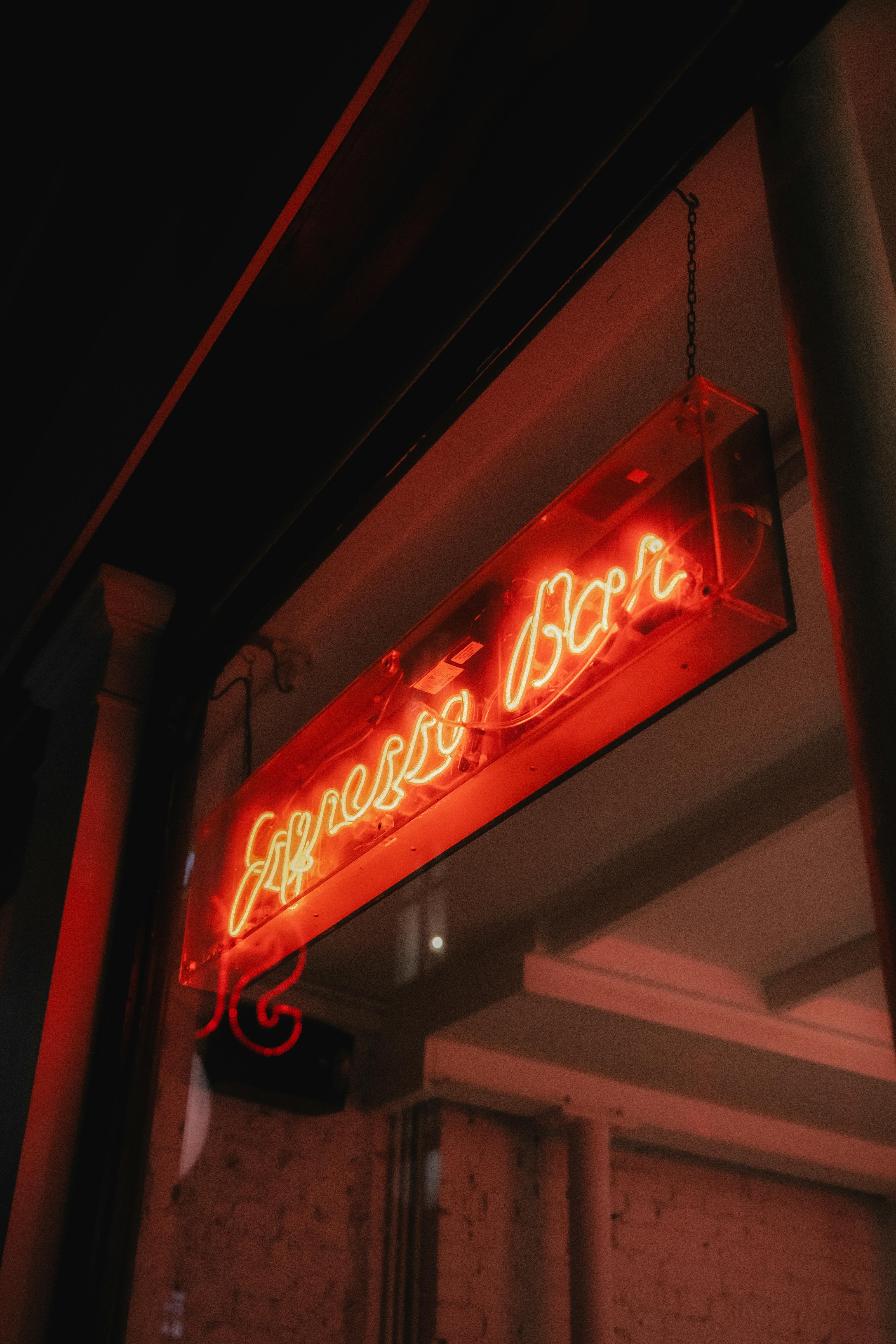 Neon Signage Hanging on a Glass window · Free Stock Photo