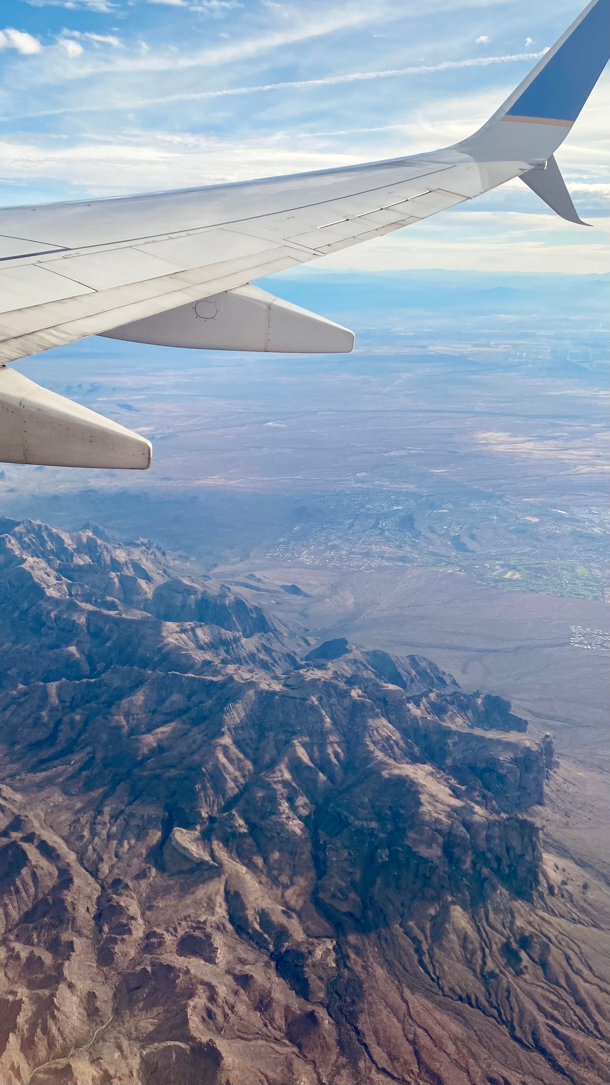 White Airplane Wing Over Mountain Ranges · Free Stock Photo
