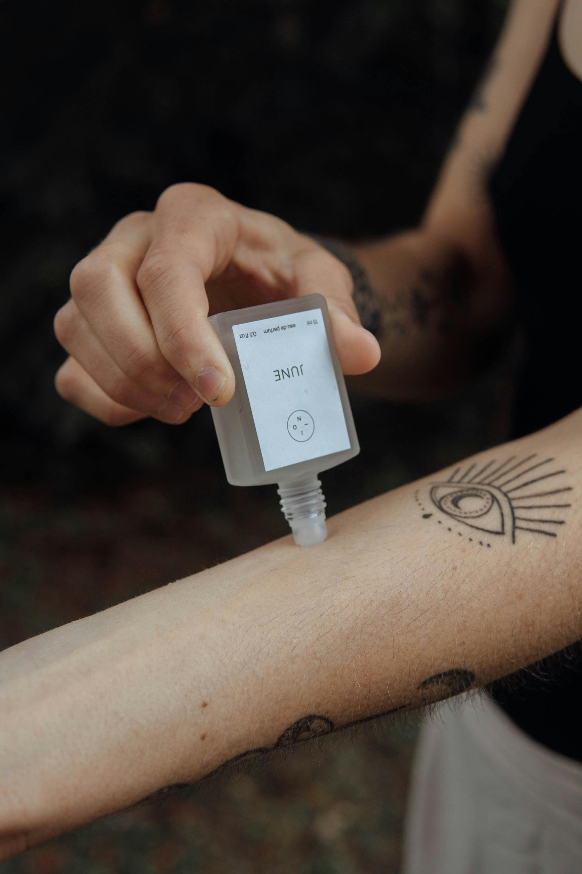 Hand Holding Flask over Arm · Free Stock Photo